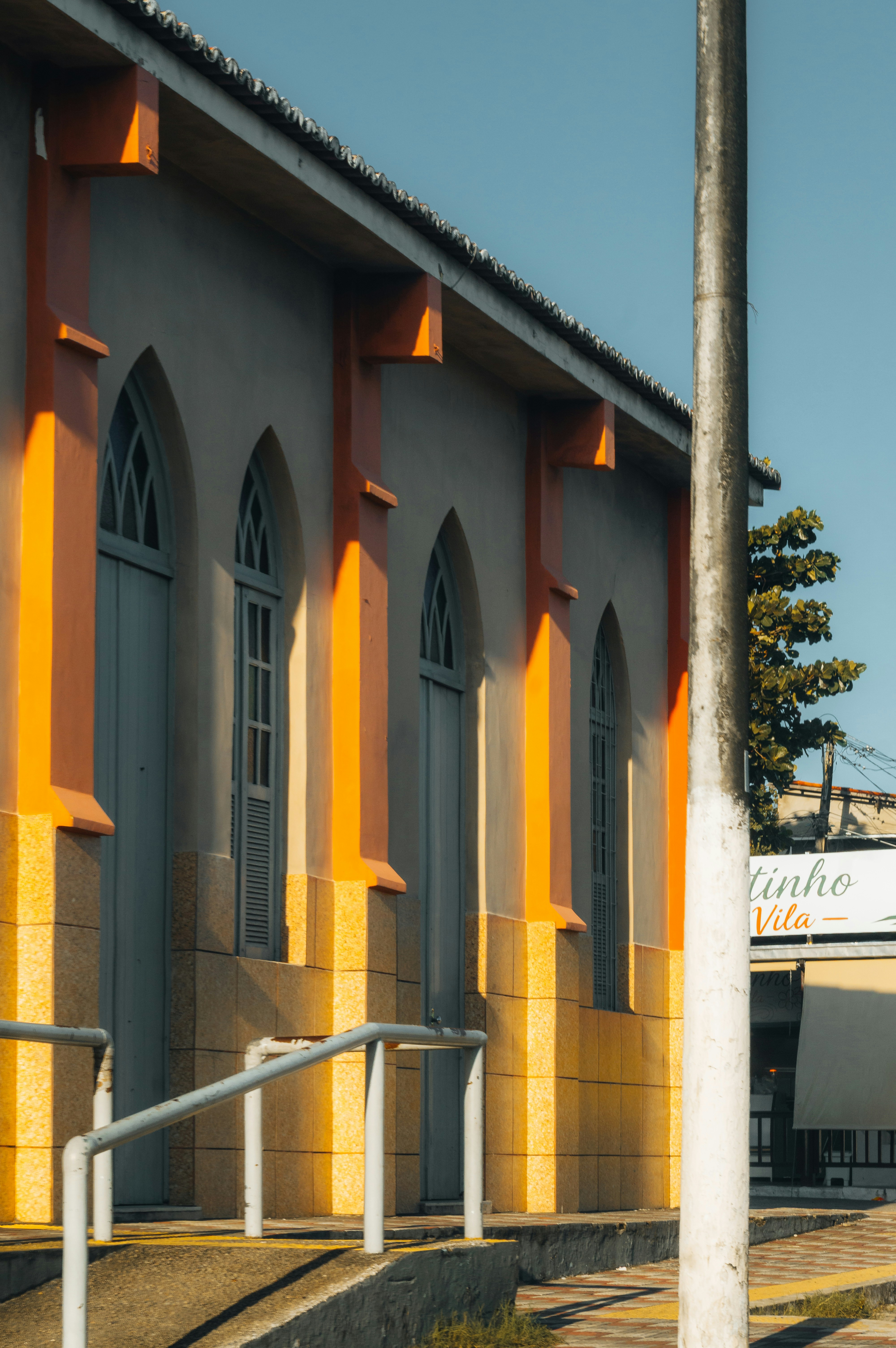 Sunlit Facade of an Orange-Trim Stationery-style Building