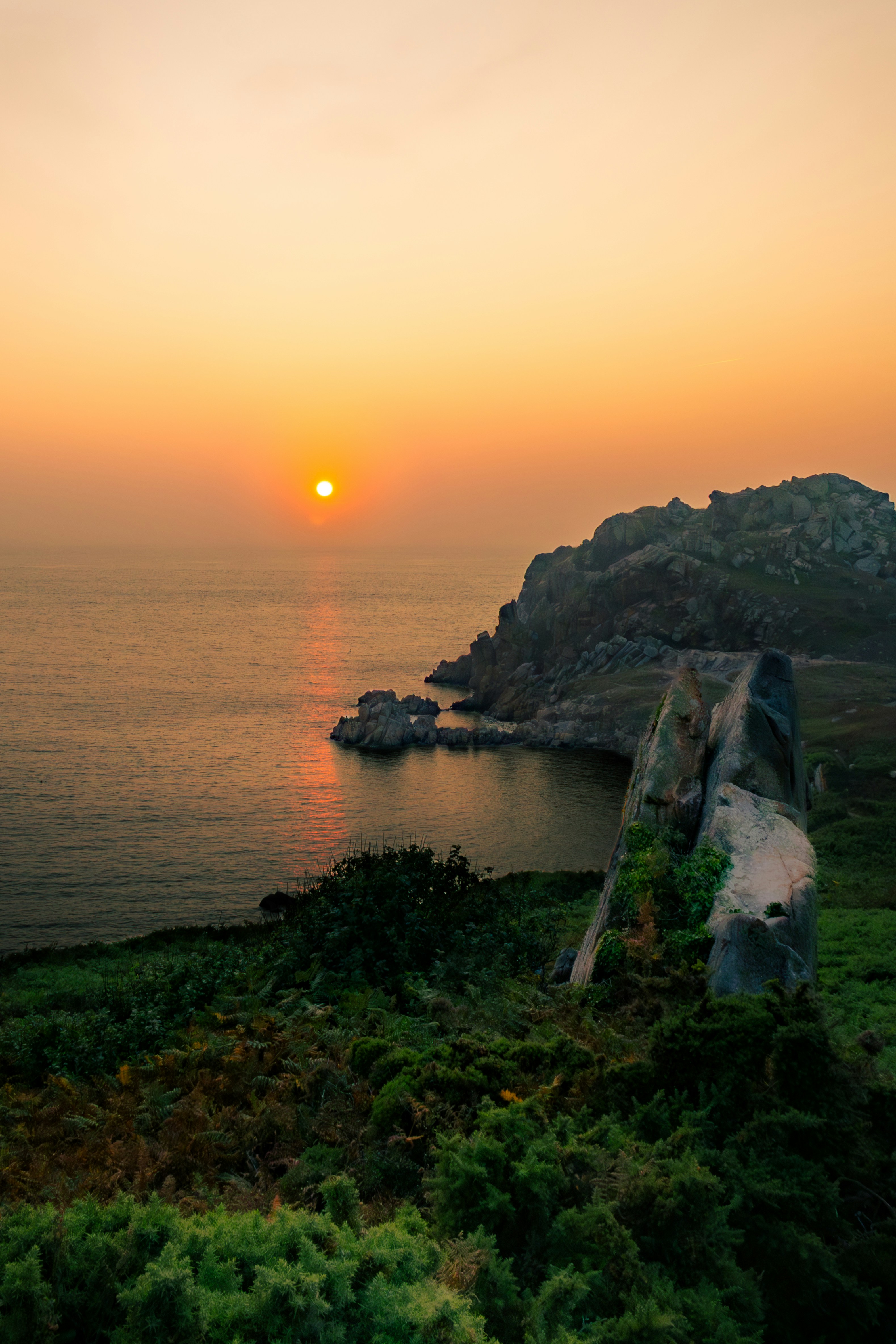 Sunlit Cliffs and Quiet Sea at Dusk
