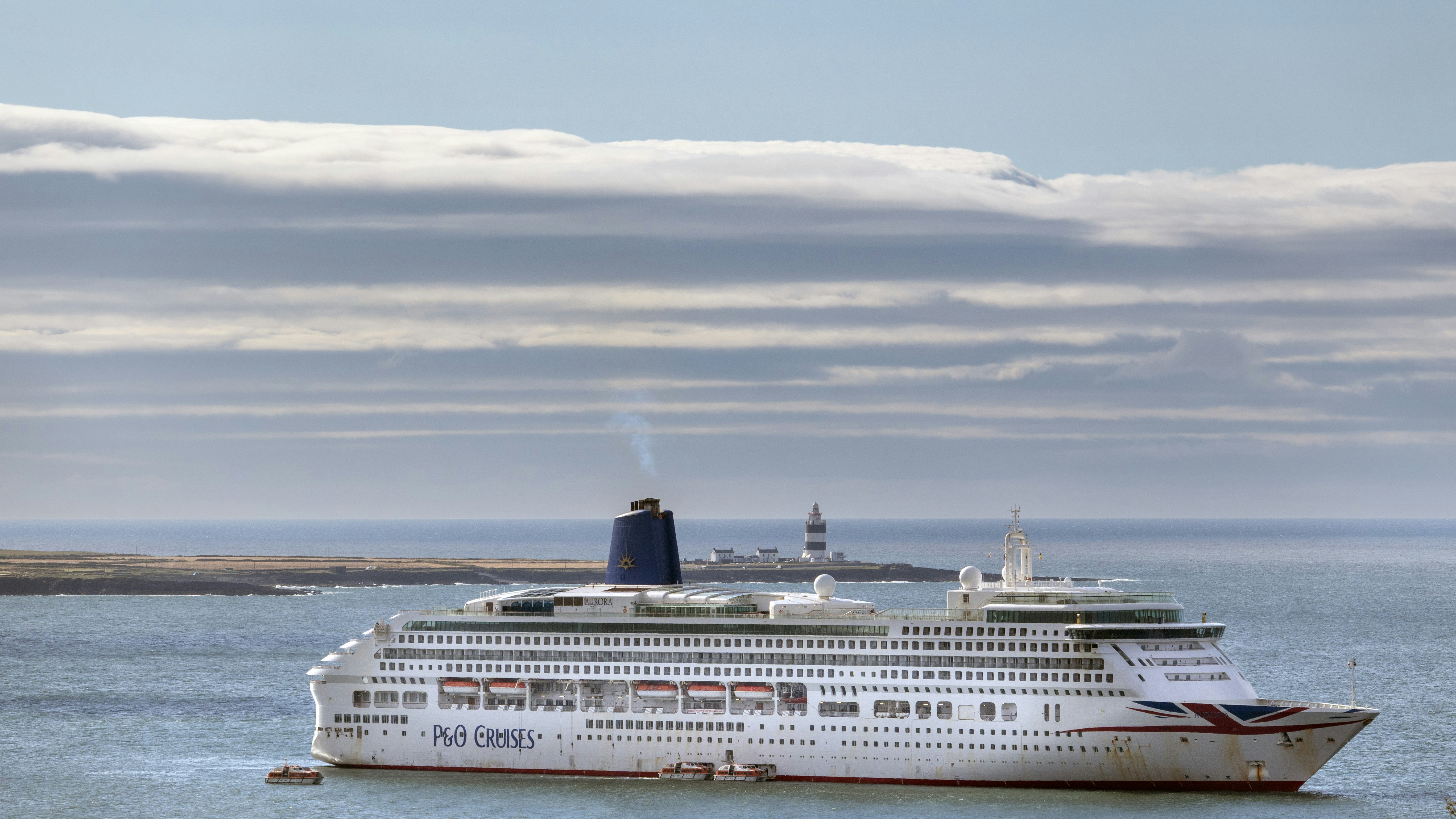 Majestic Ocean Crossing: A White Cruise Ship Glides Past a Calm Horizon