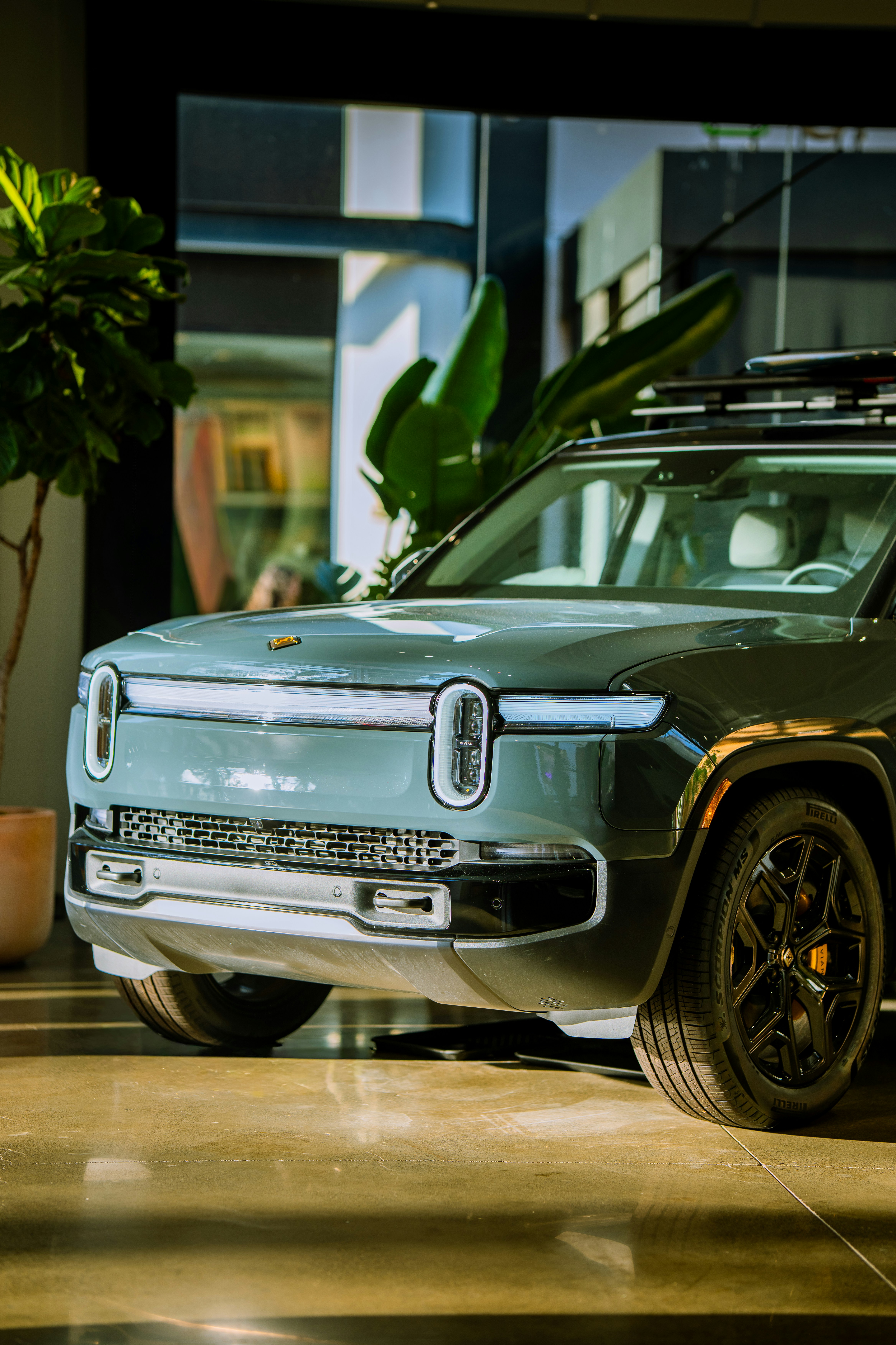 Midnight Blue SUV Emerges Under showroom Glow