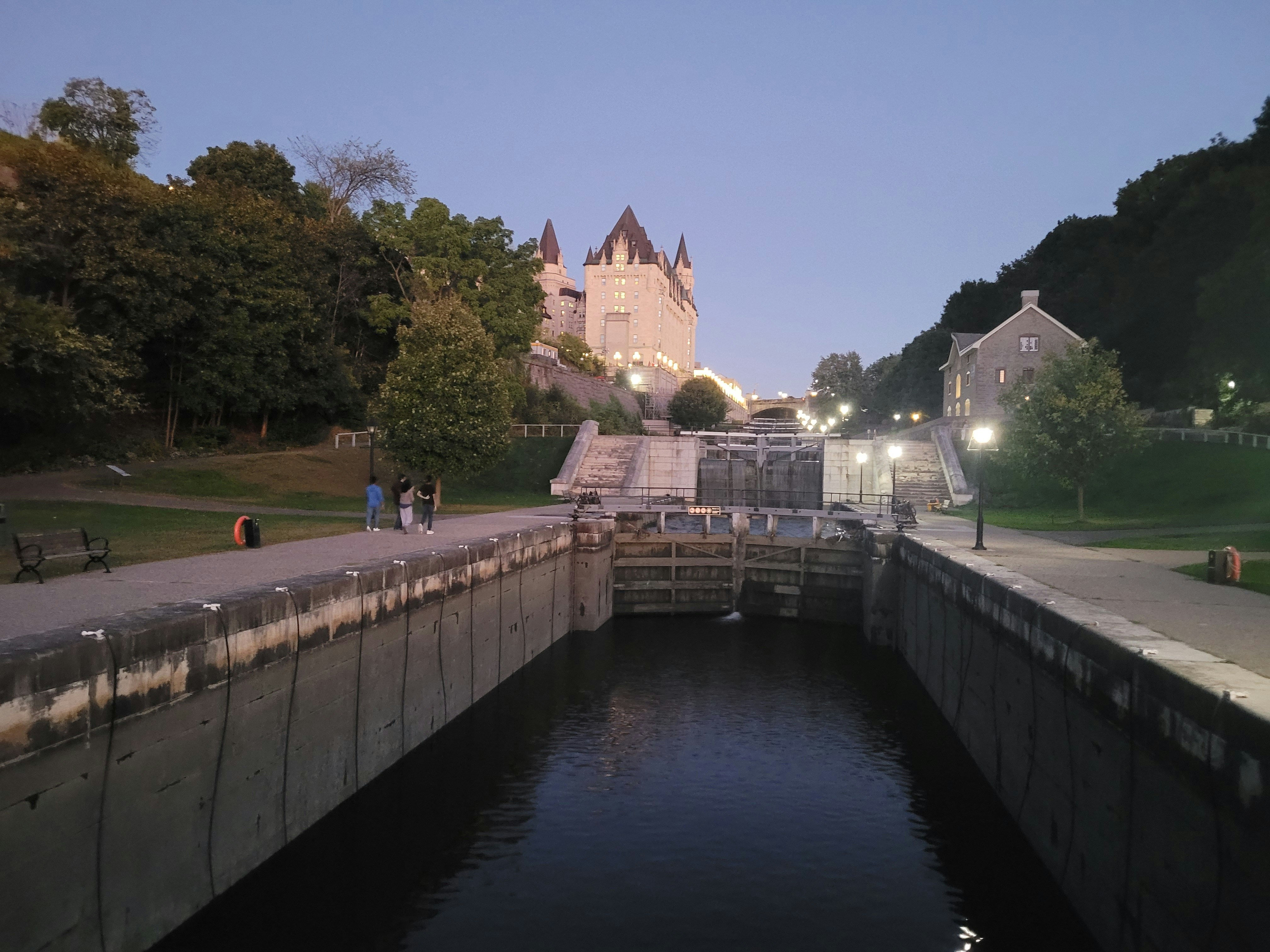 Castle Gate at Dusk: A Tranquil Canal Approach to a Pierced City