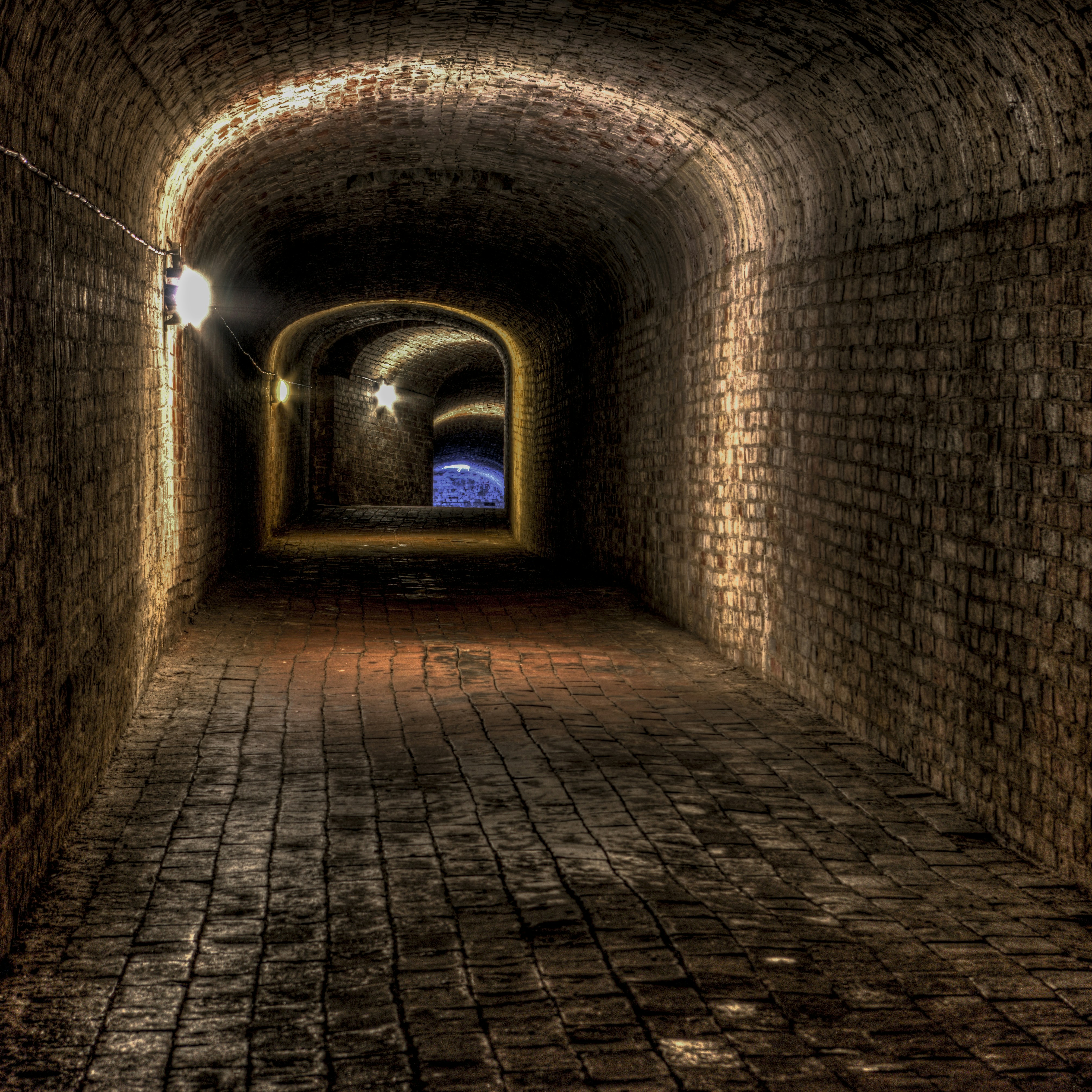Archway Corridor: A Veil of Light in the Brick Tunnel