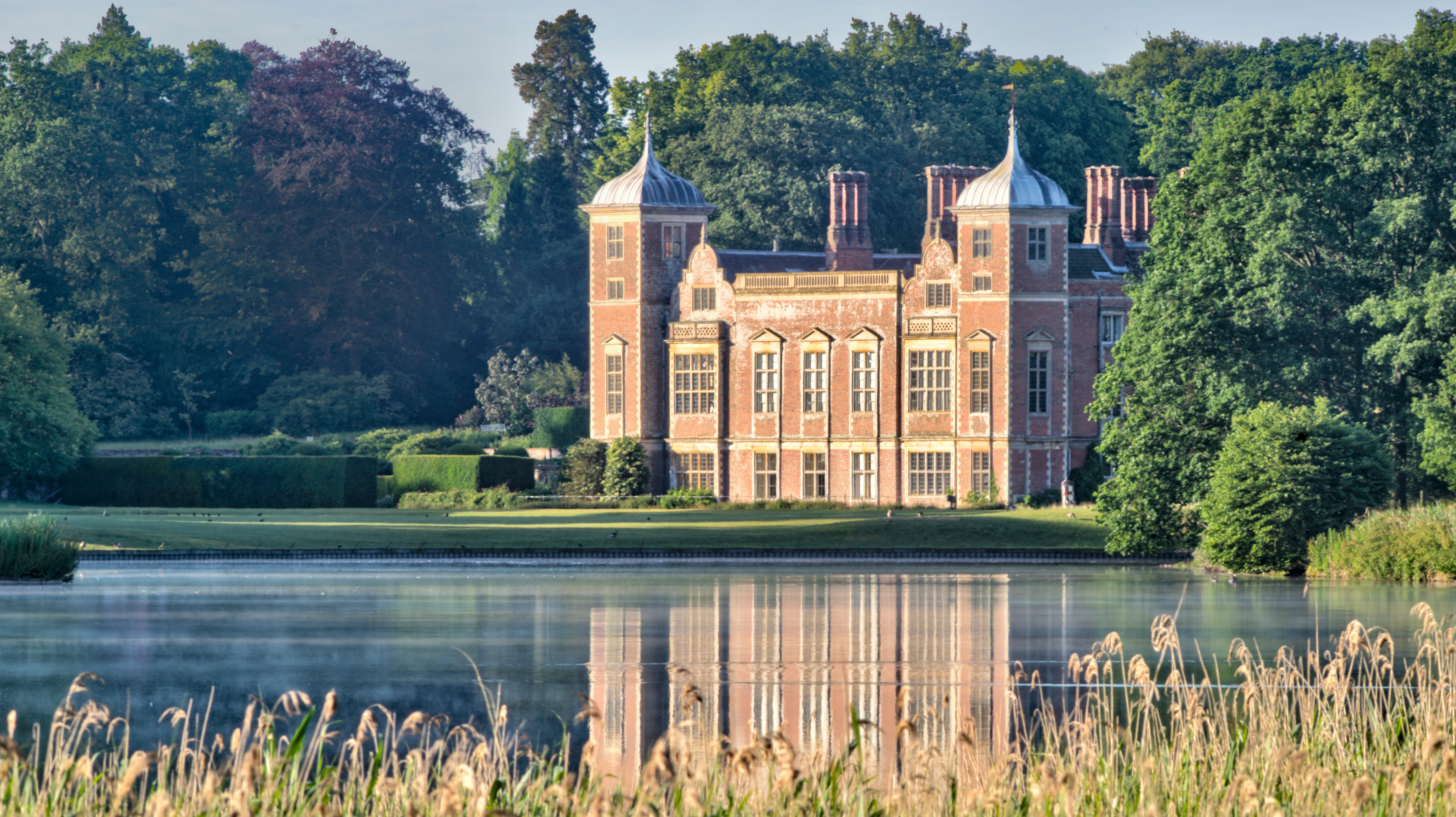 Castle by the Lake: A Brick Fortress Rippling with Calm Reflections