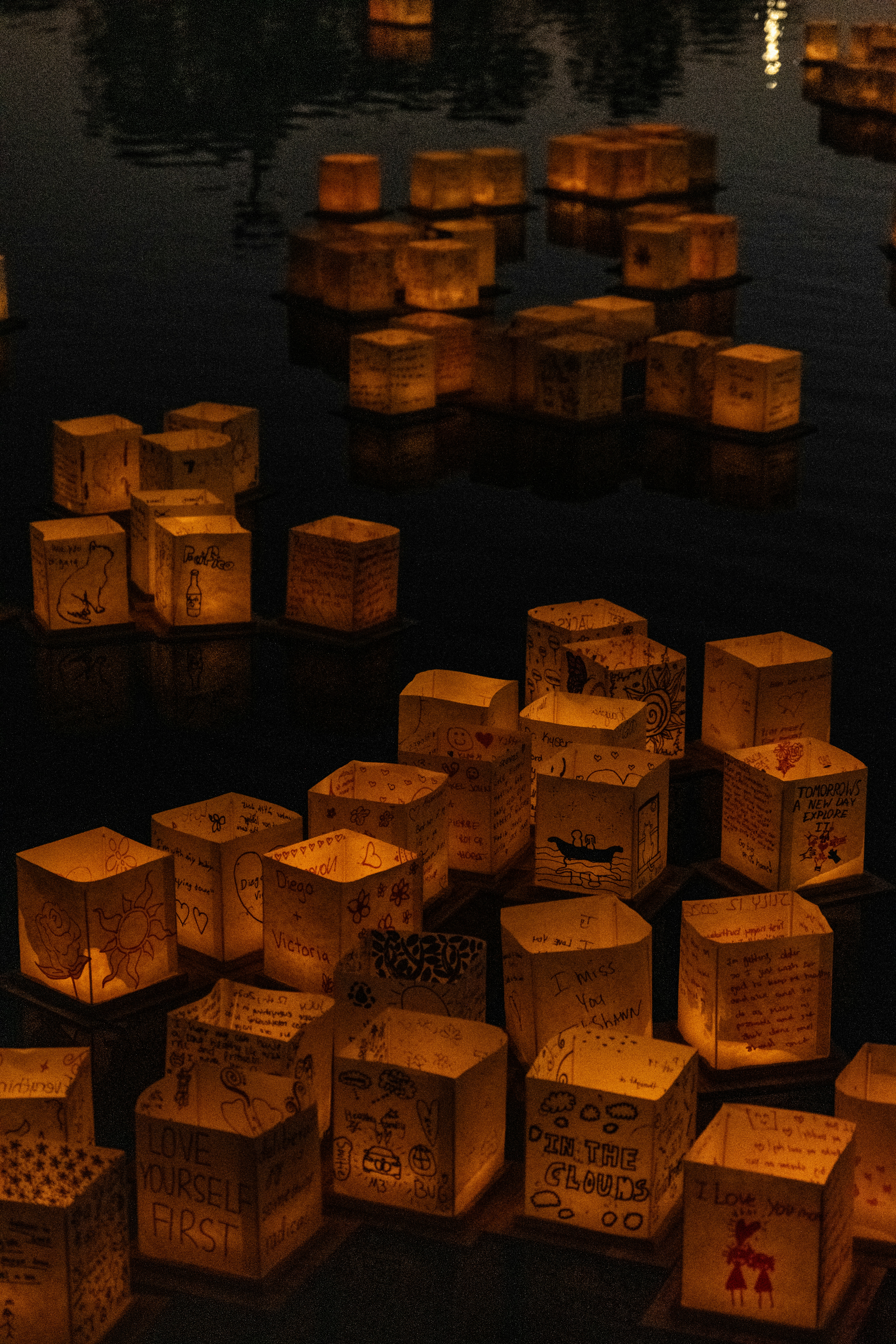 Floating Lantern Mosaic: Warm Messages Across a Dark Pond