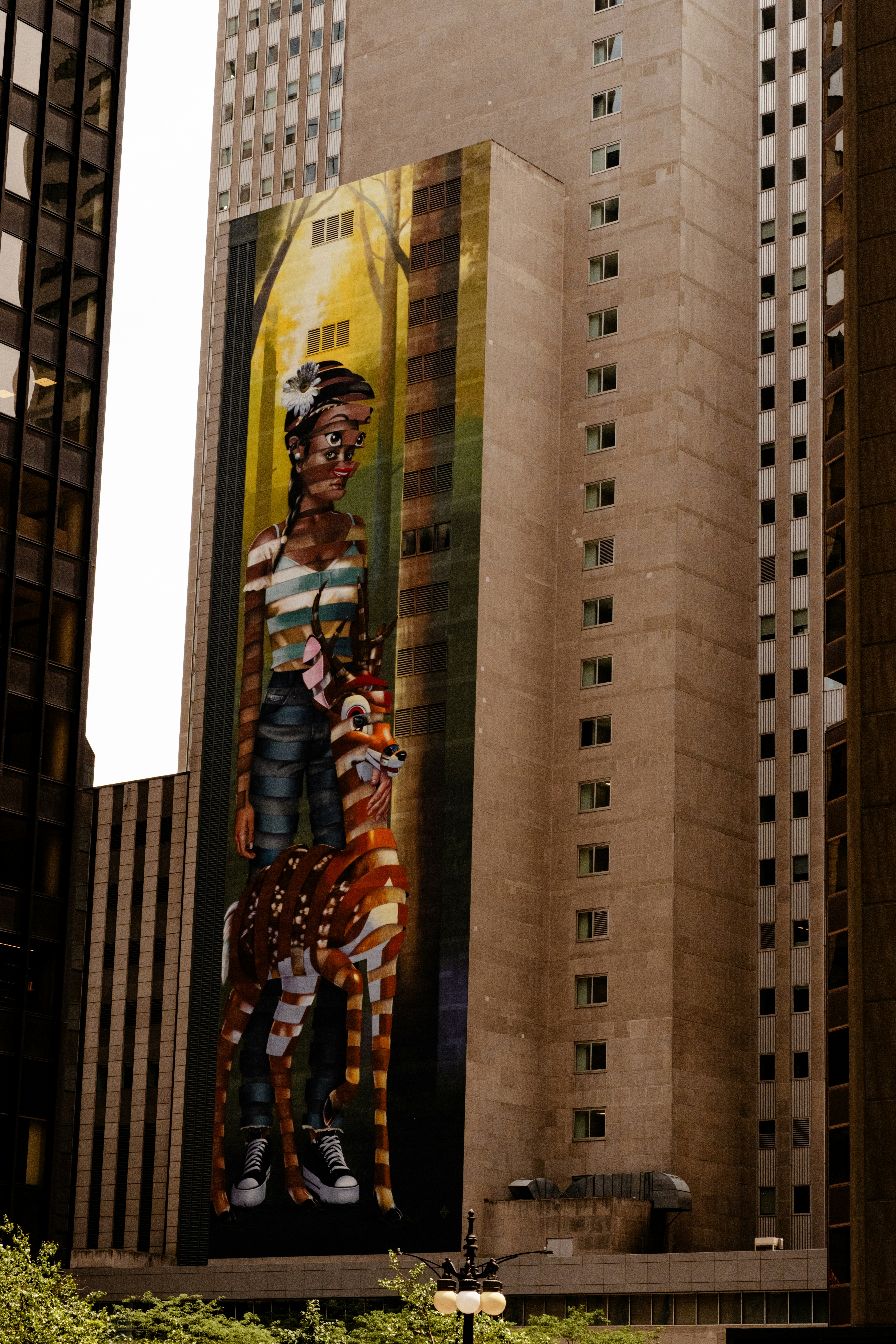 Portrait mural on a skyscraper: a fashion-forward figure painted on a towering wall