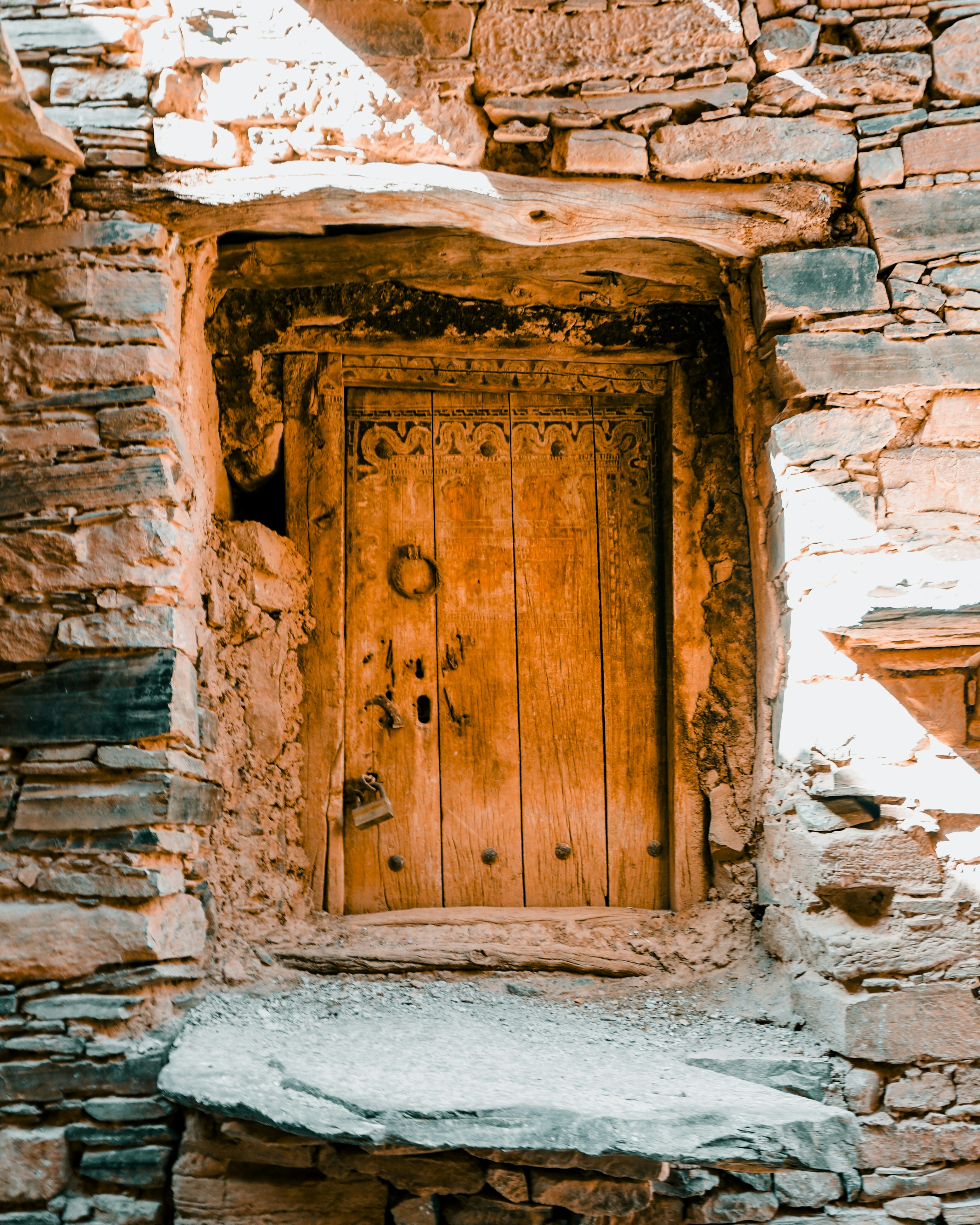 Weathered Portal: A Wooden Door Set in A Stone Way