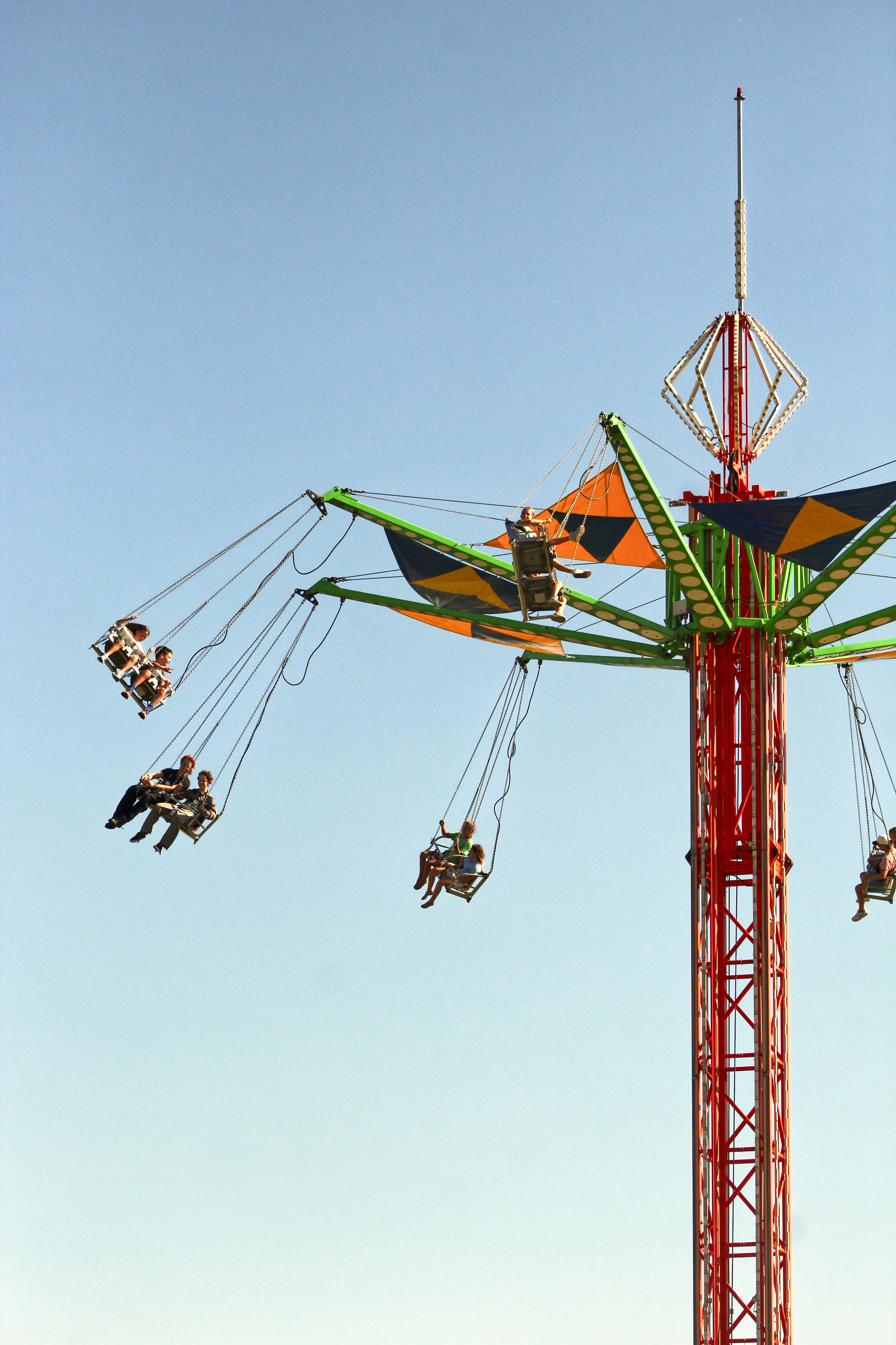 Skyward Swing: Riders in a Daring Carousel