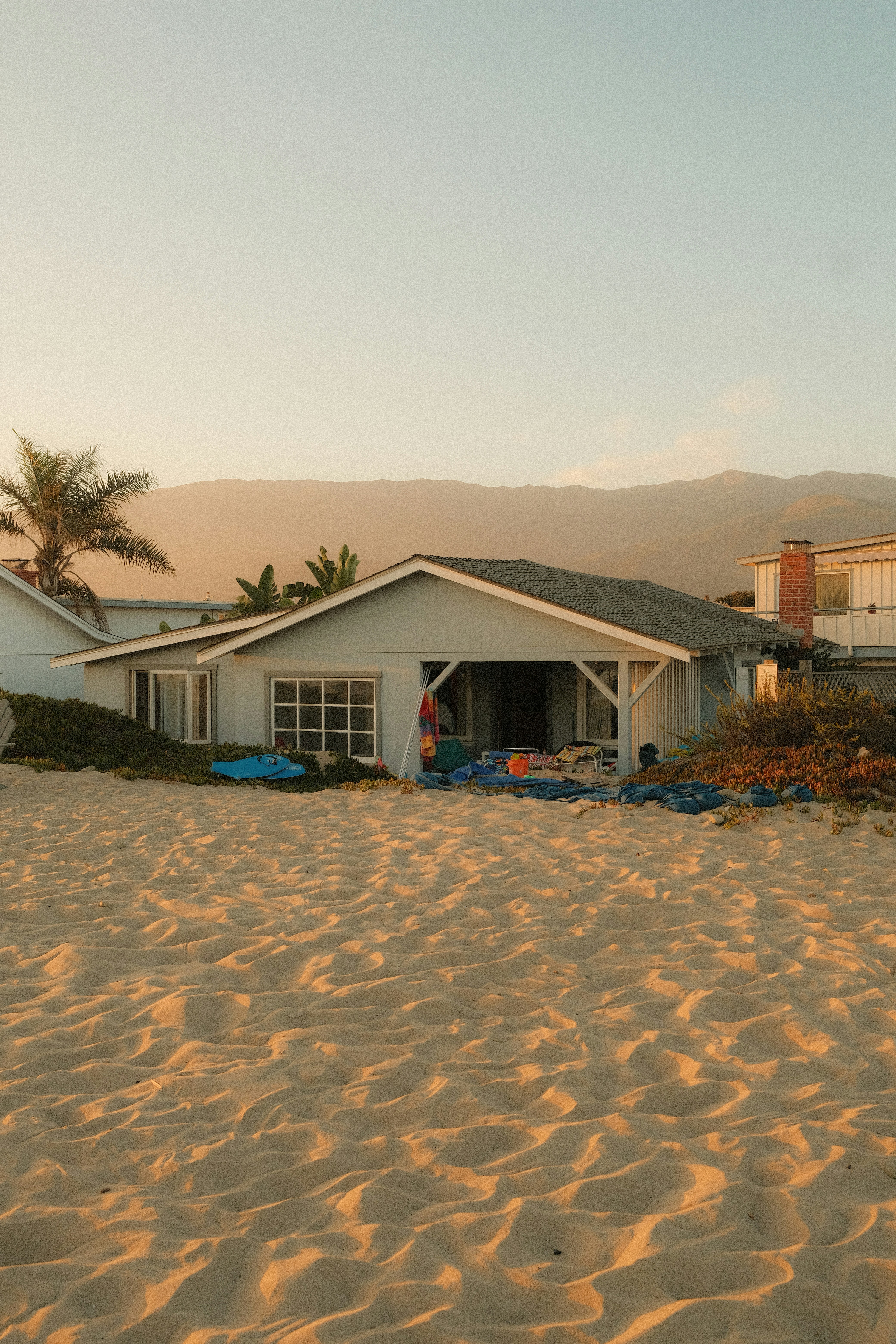 Sunlit Beach House on Wind-Swept Sand