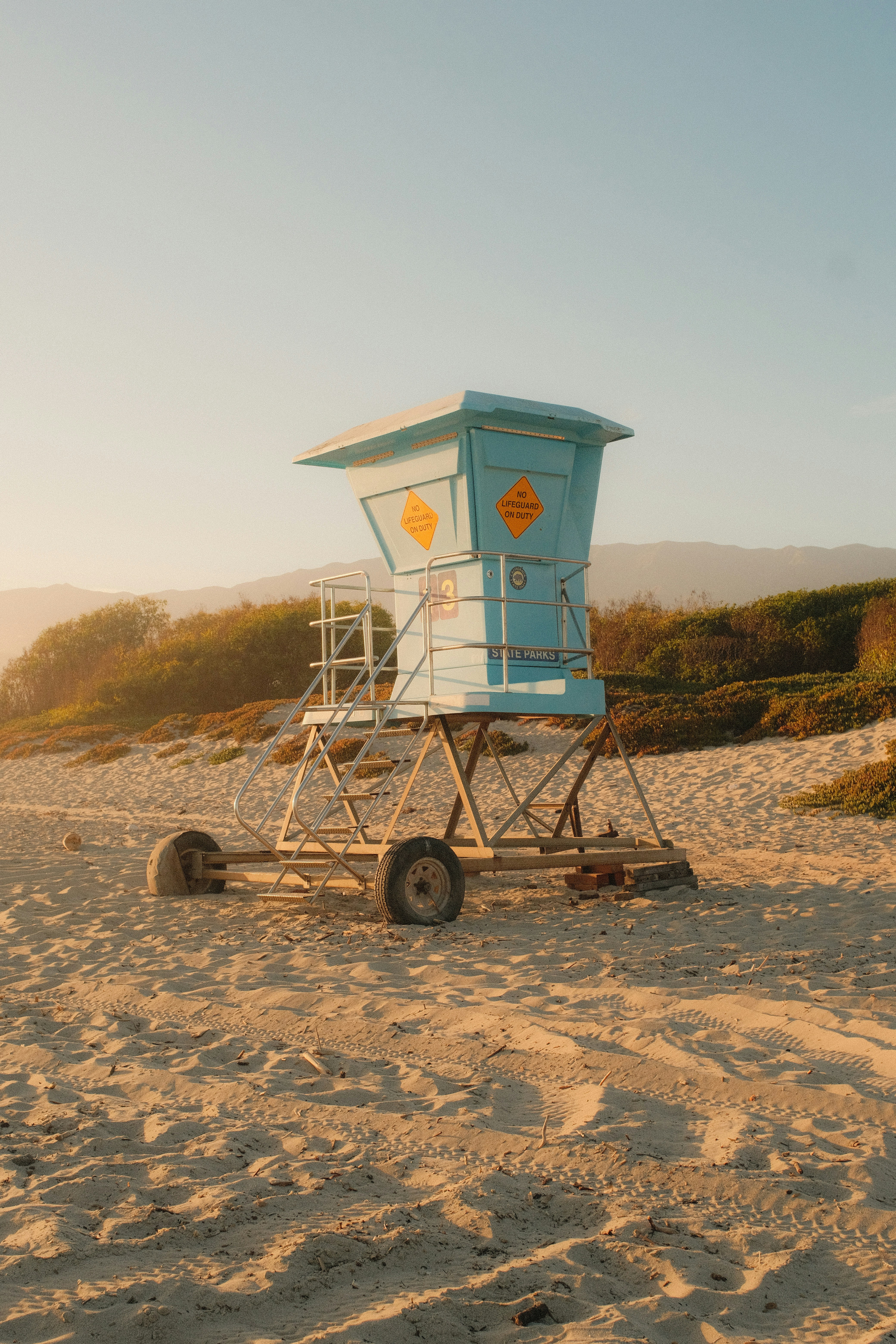 Lifeguard Tower Afloat on Dune Sea at Sunset