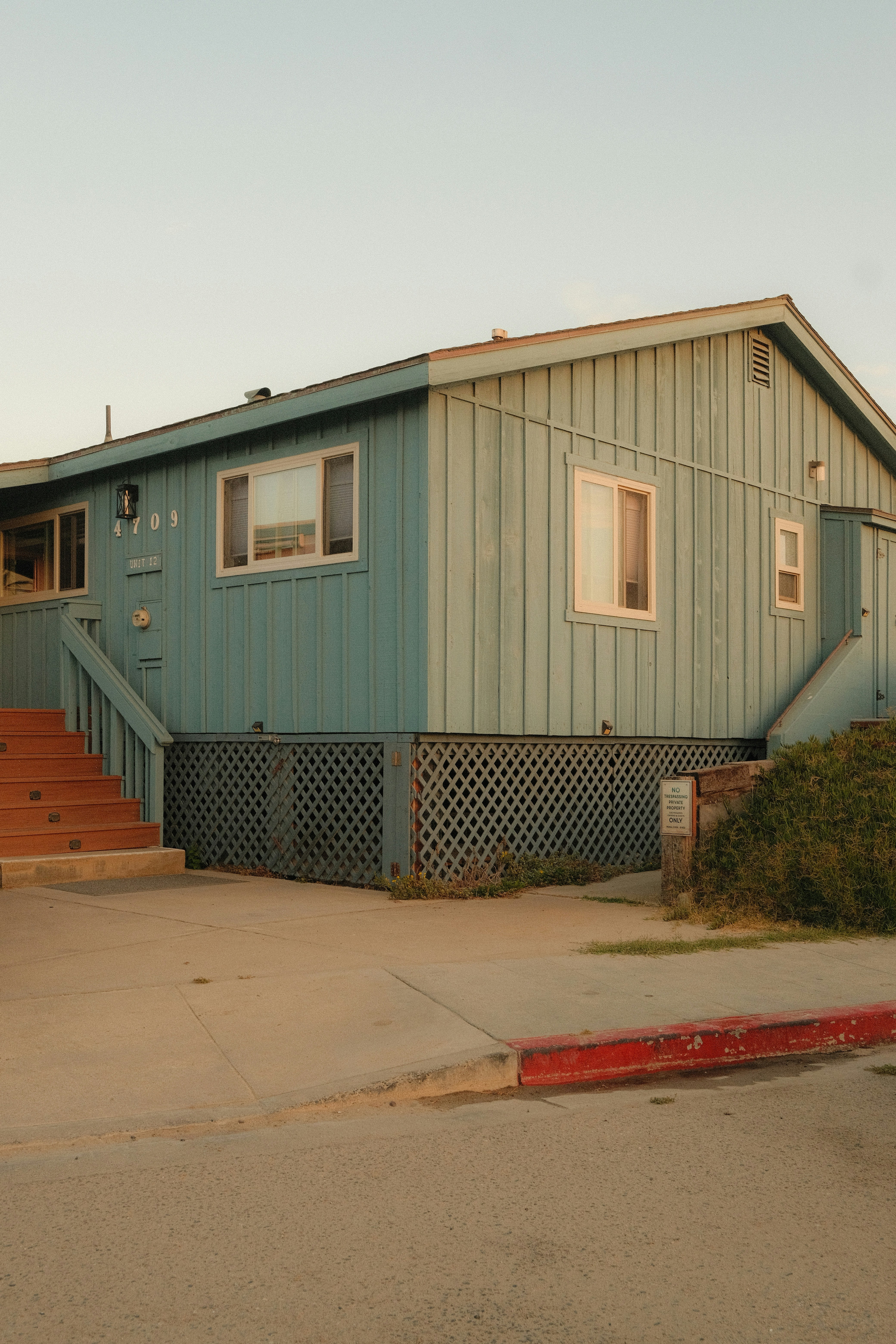 Coastal Blue House: Stairs to Sunlit Porch and Quiet Street