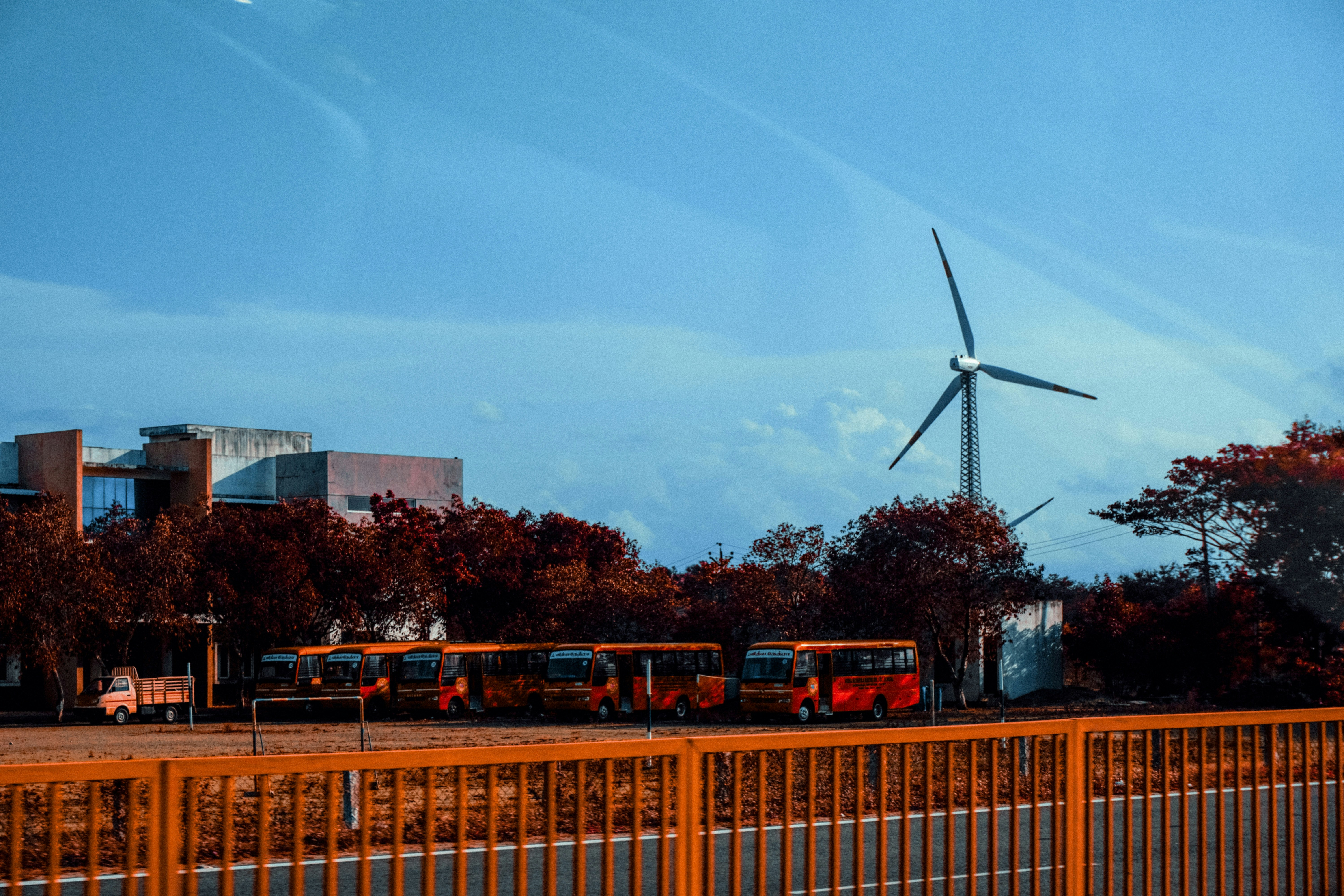 Wind Turbine Overlook: Orange Bus Line Under a Summer Sky