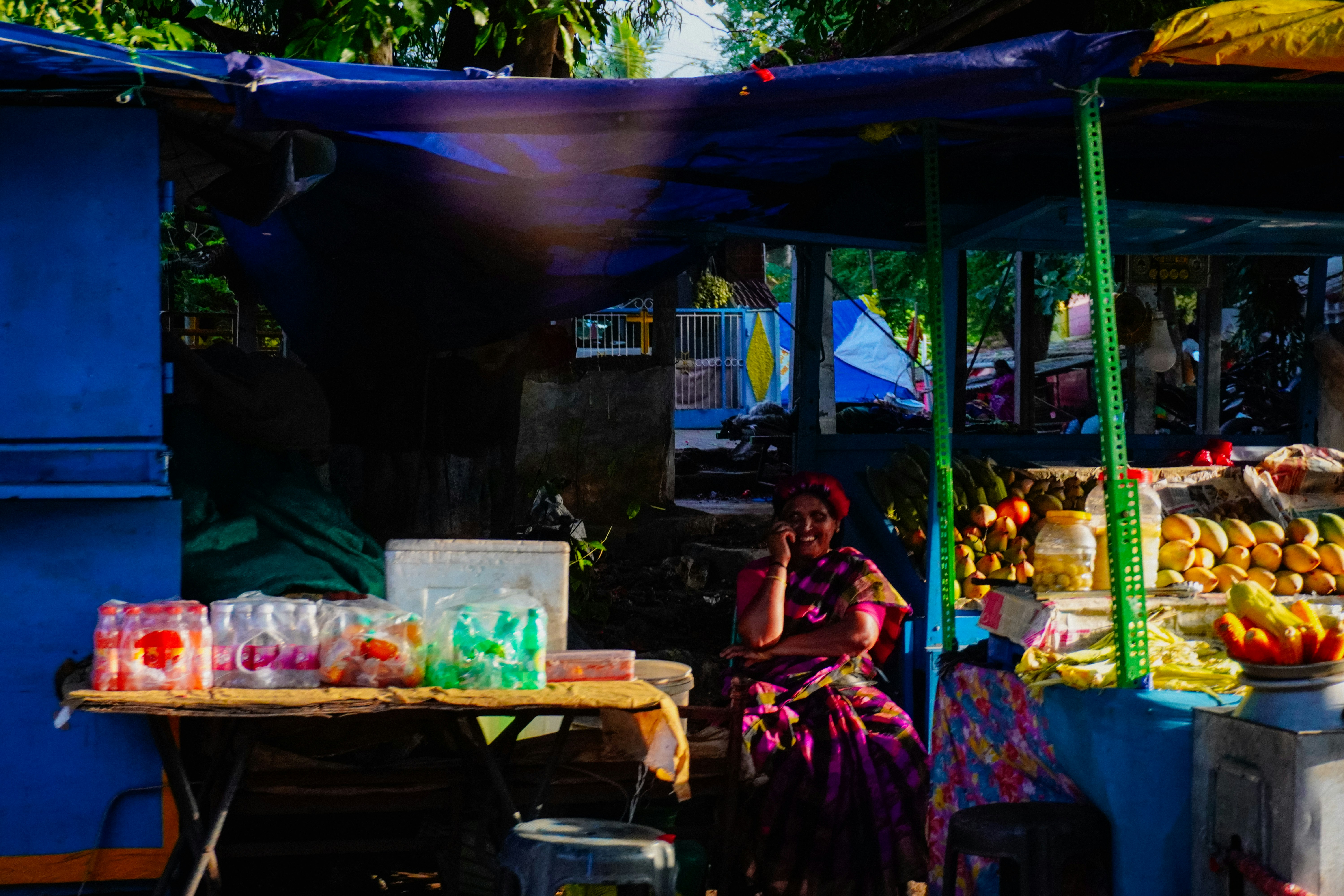 Shadows and Stacks: A Quiet Moment Behind the Market Stall