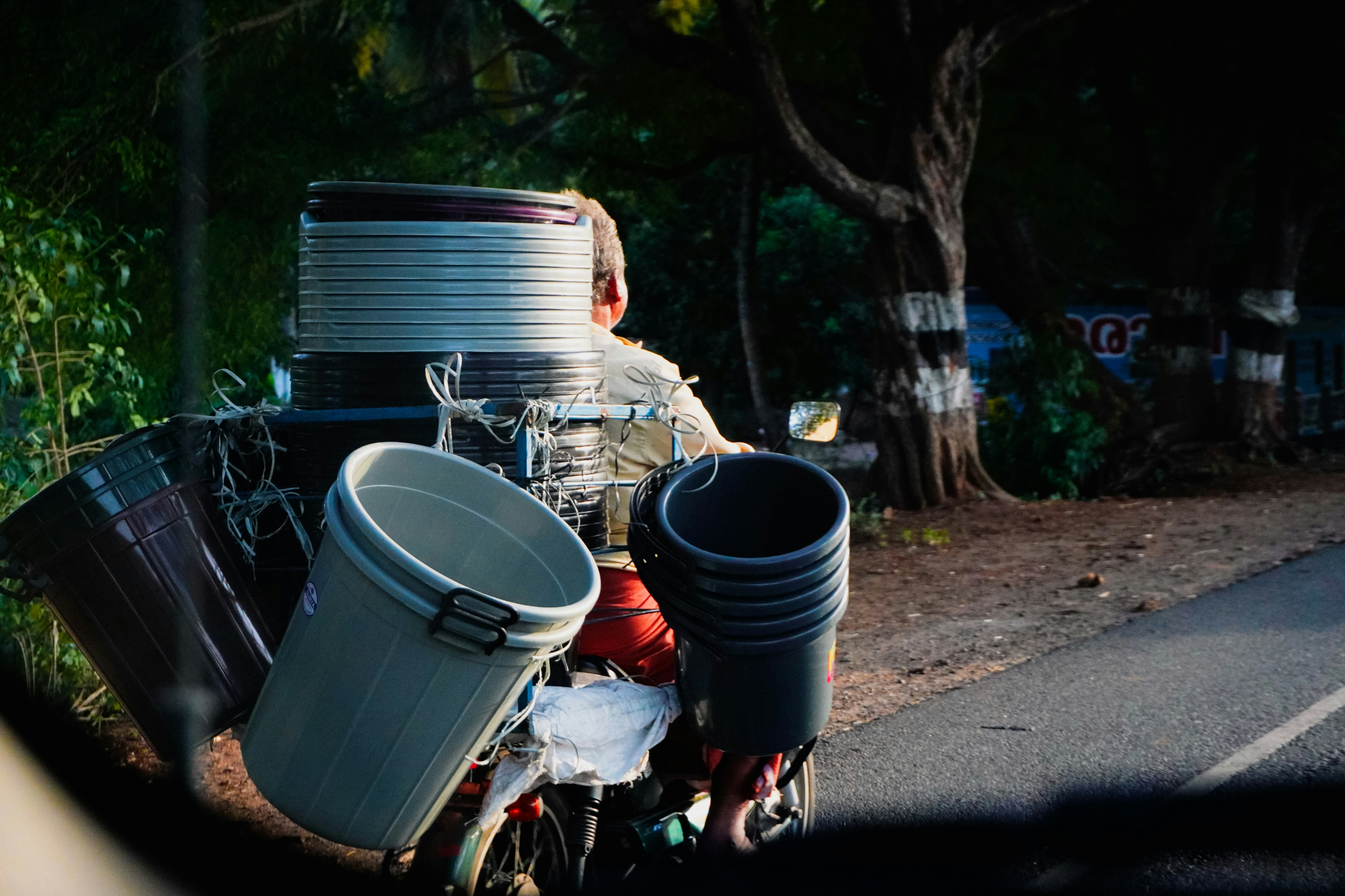 Station of Drained Gear: A Surreal Bike Laden with Buckets in a Quiet Roadside