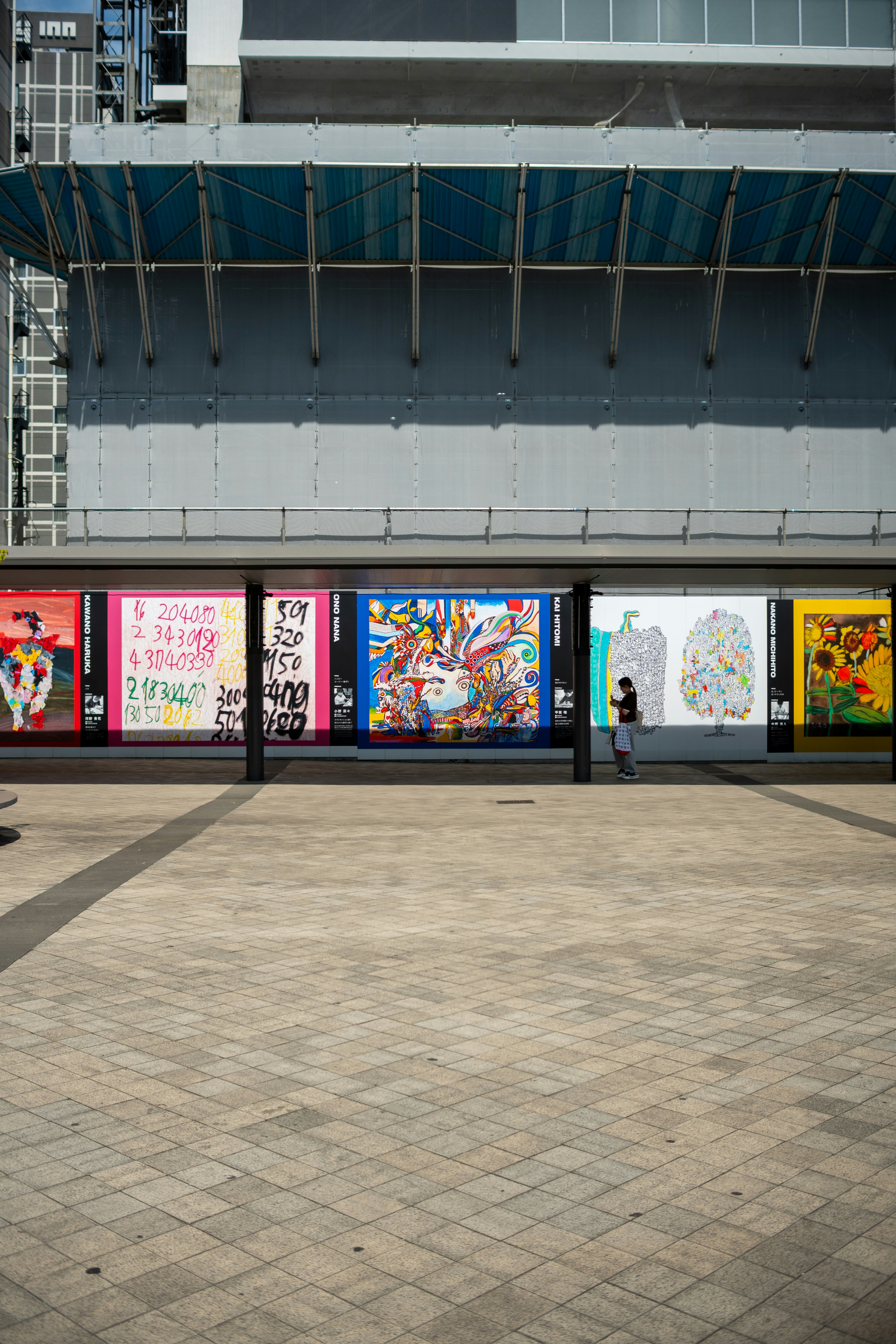Colorful storefronts under a modern urban canopy