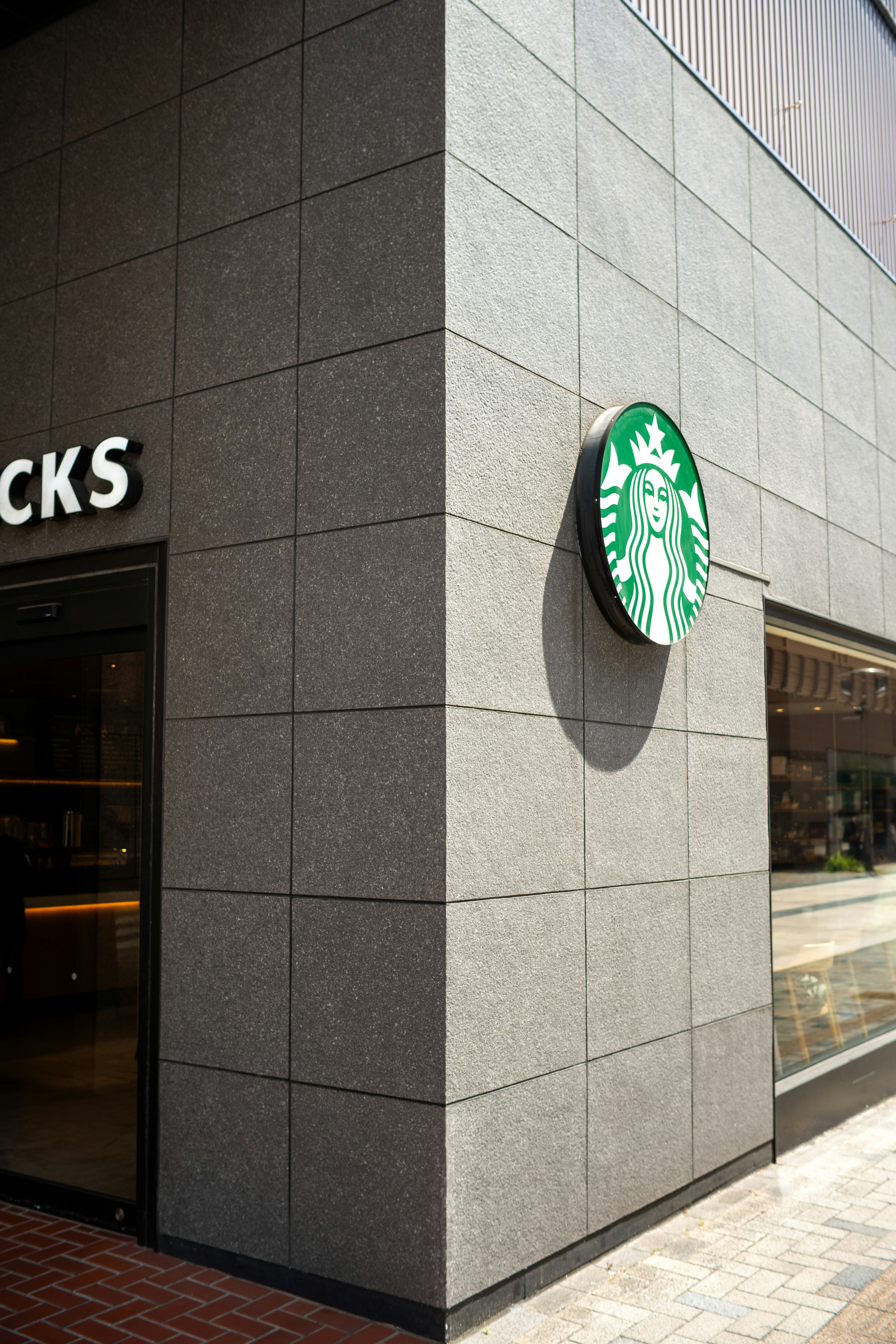 Starbucks Corner: Green Emblem on a Granite Facade