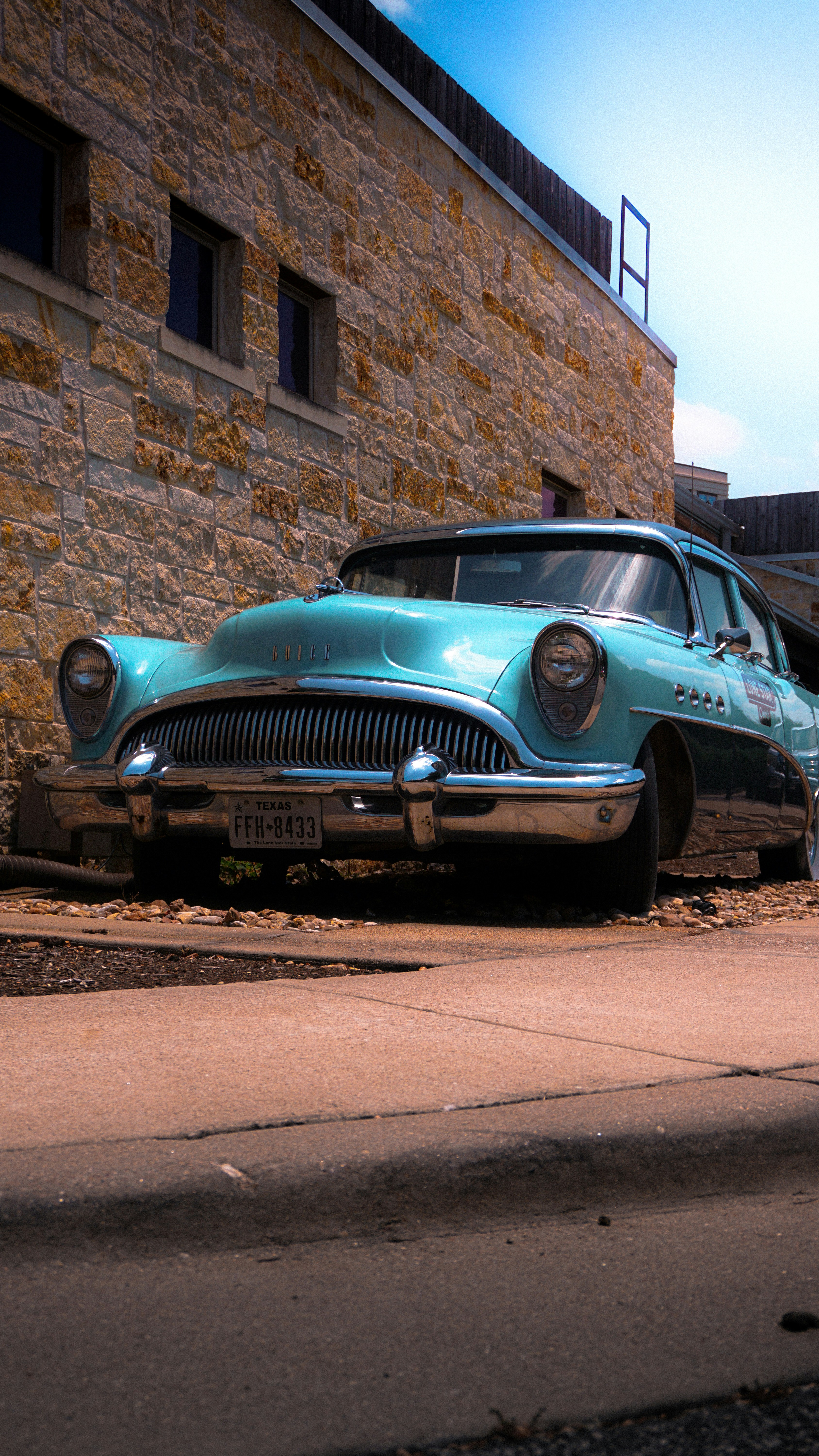 Azure Classic: a sunlit vintage cruiser amid stone walls