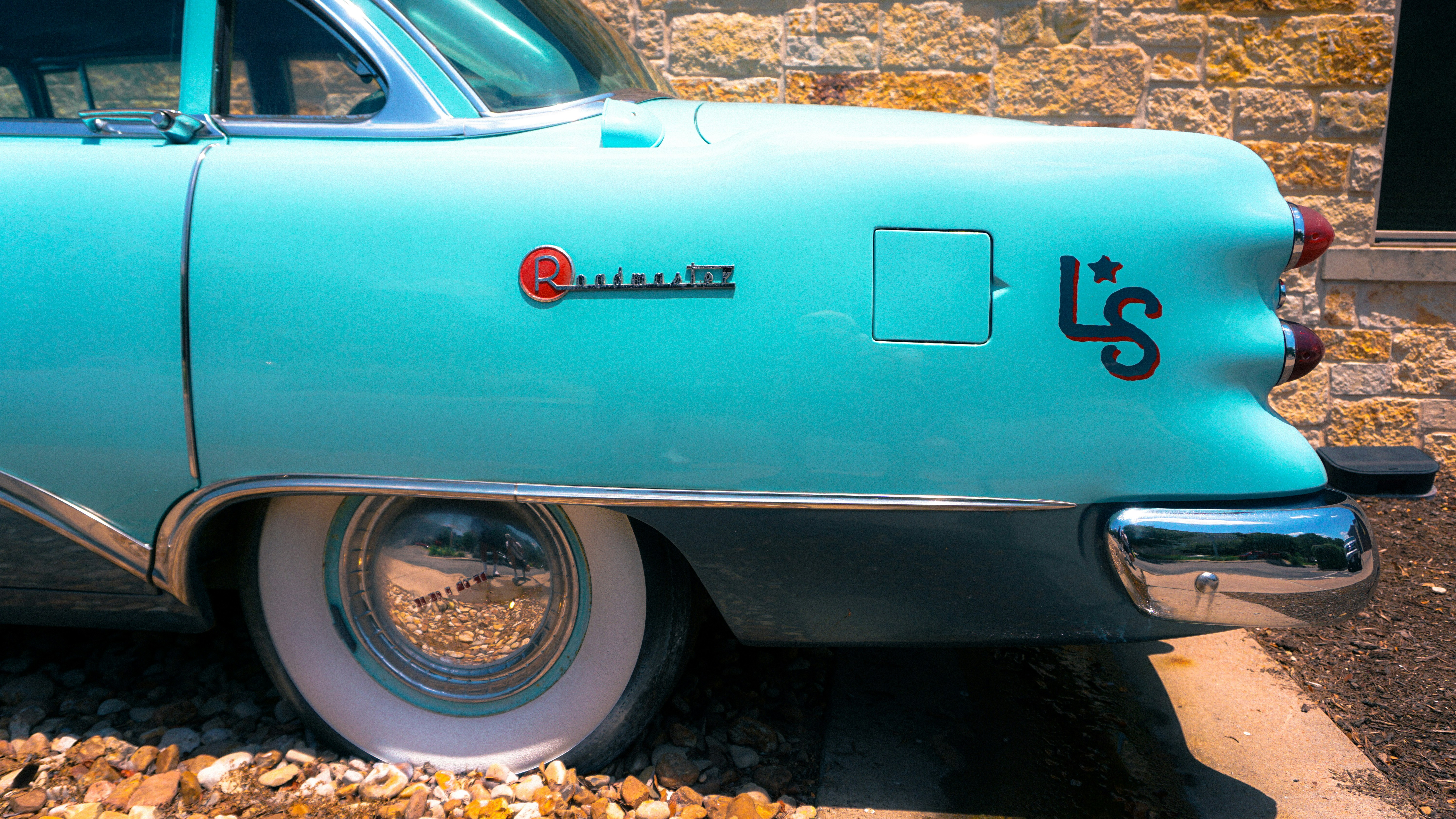 Tailfin turquoise: a sunlit classic Chevrolet with chrome and whitewall gleam