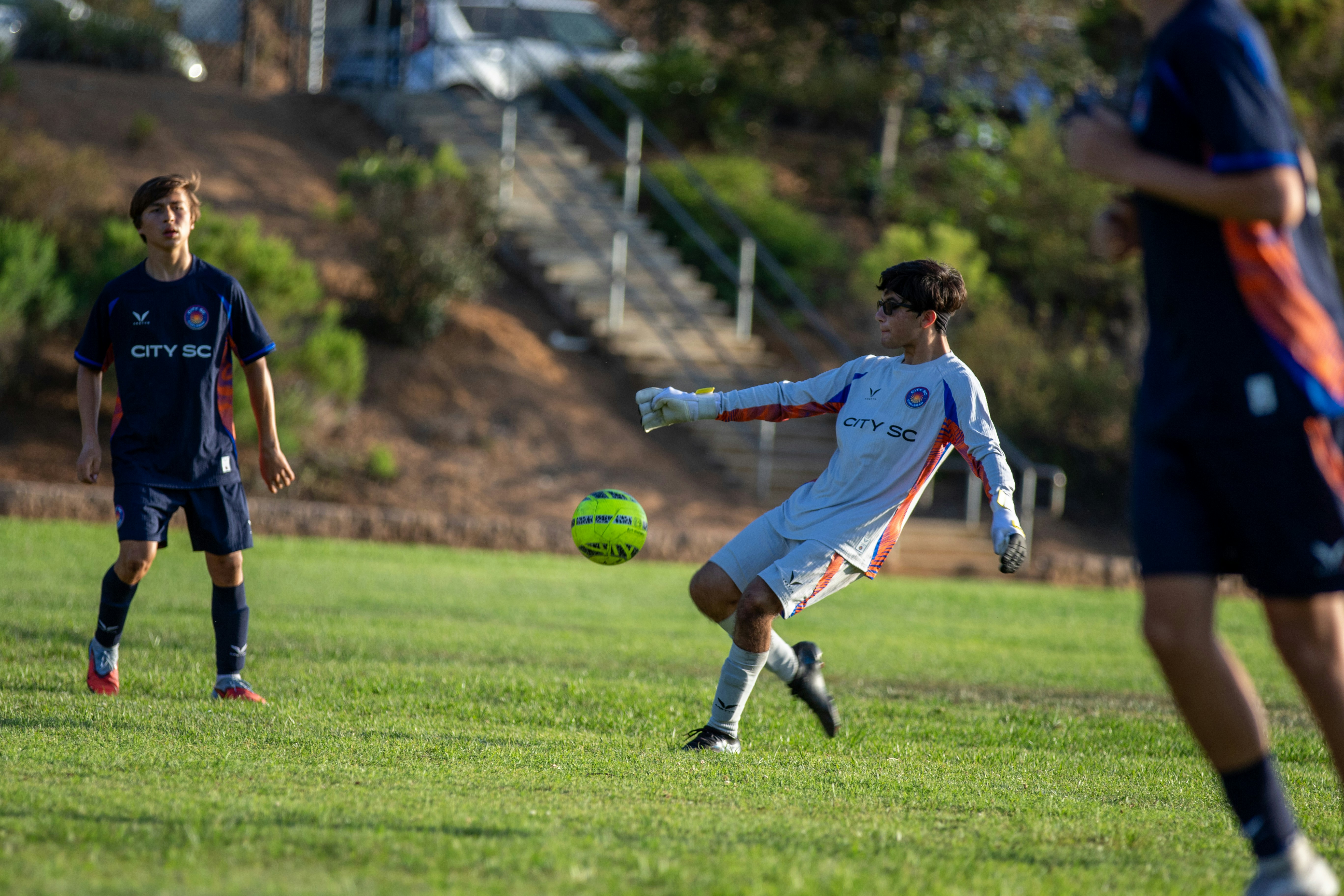 Midfield Magic: A Player Strikes as Others Stand by