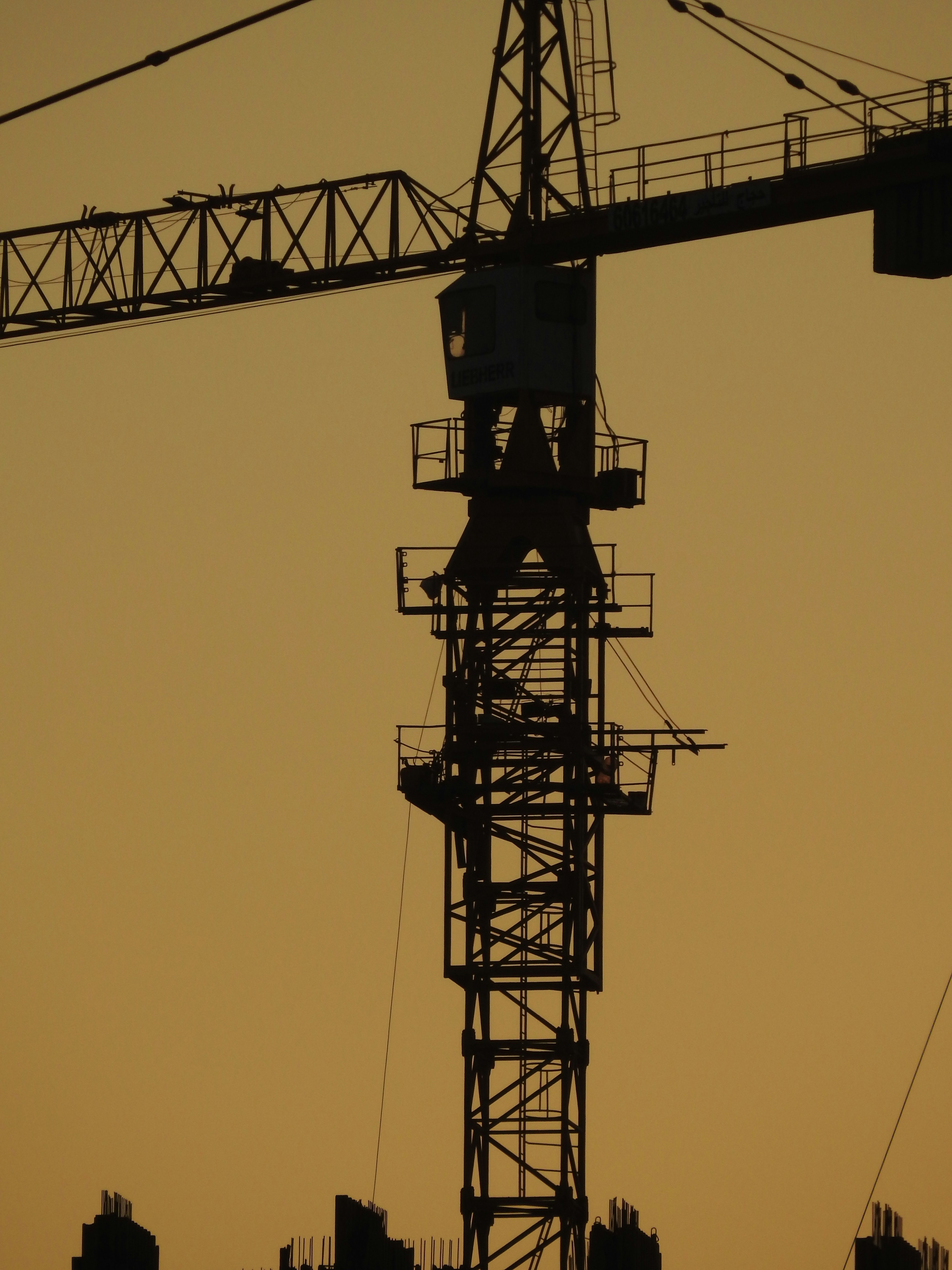 Silhouette of a Tower Crane Against a Warm Sundown