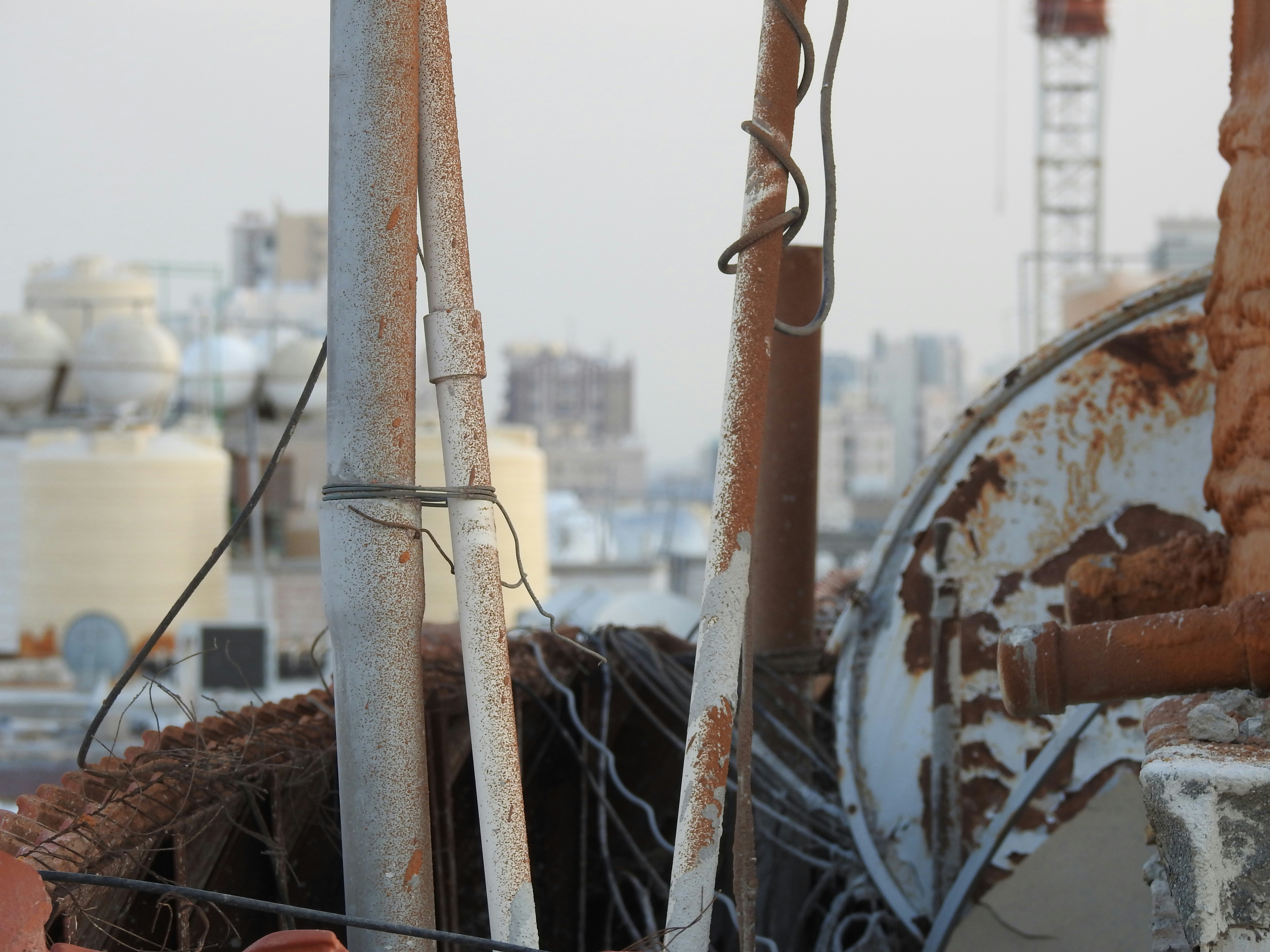 Rusted Machinery in the City Roofscape