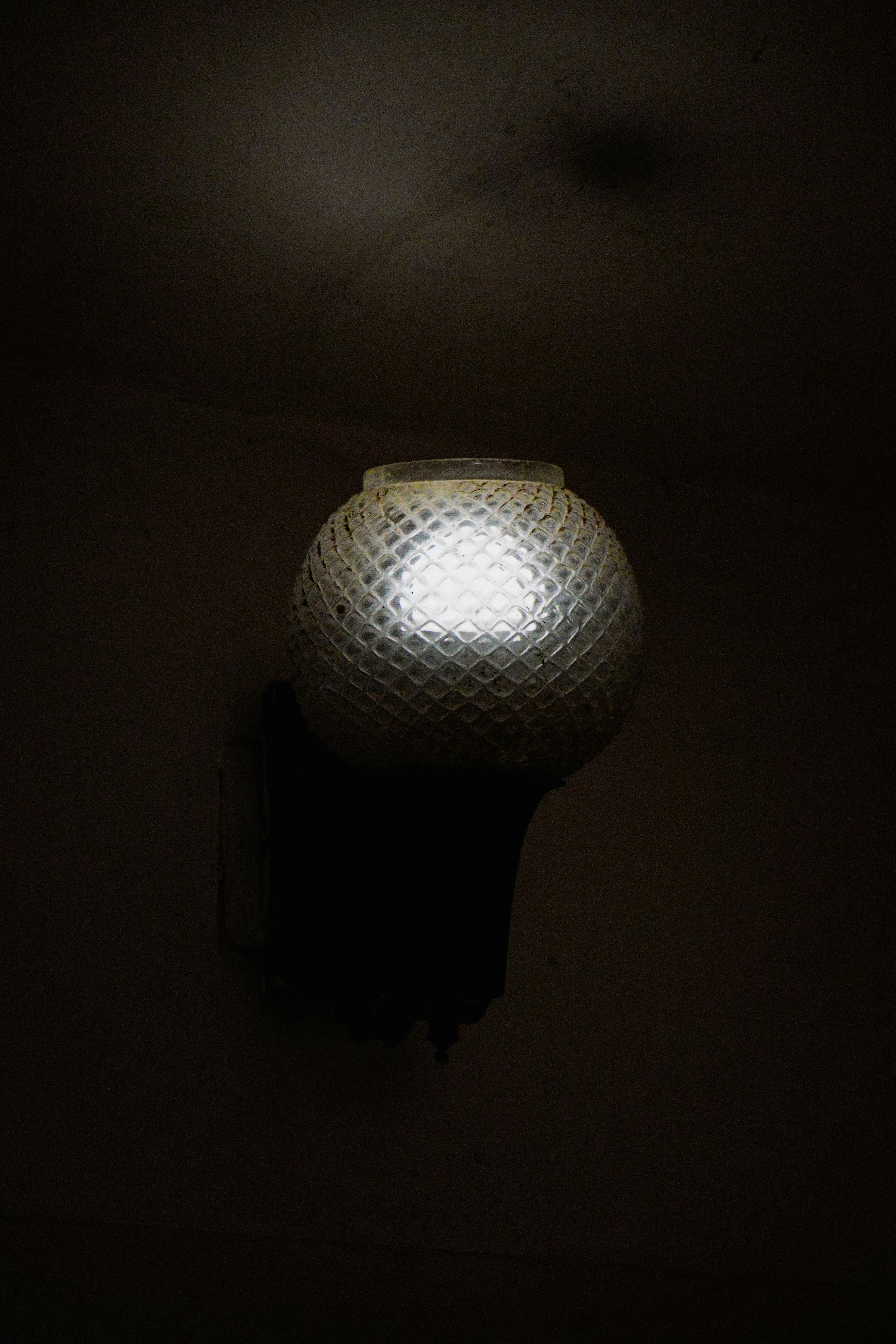 Dim Glow: A Glass Globed Lamp in Quiet Shadow