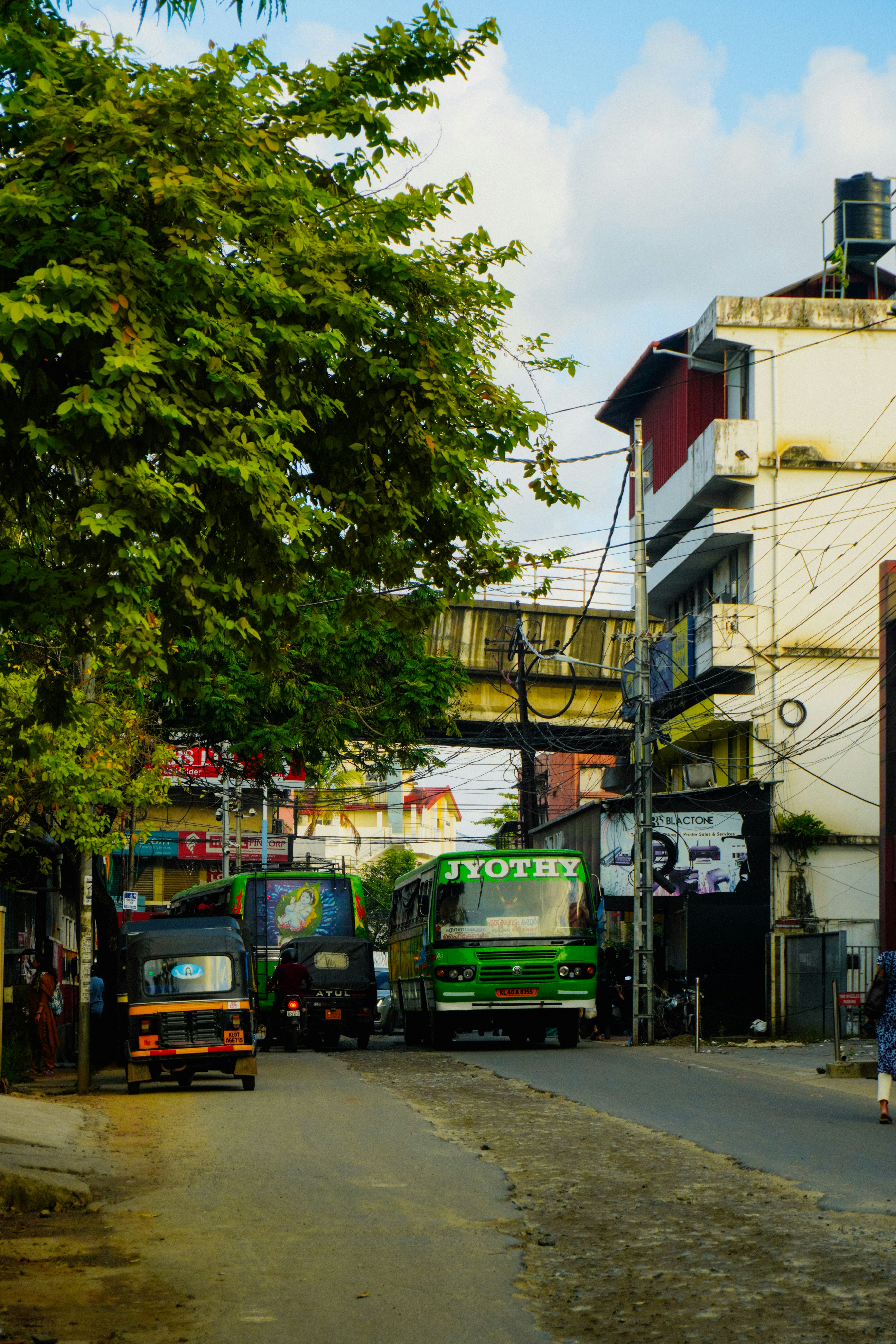 City Street in Motion: Green Bus at a Busy Intersection