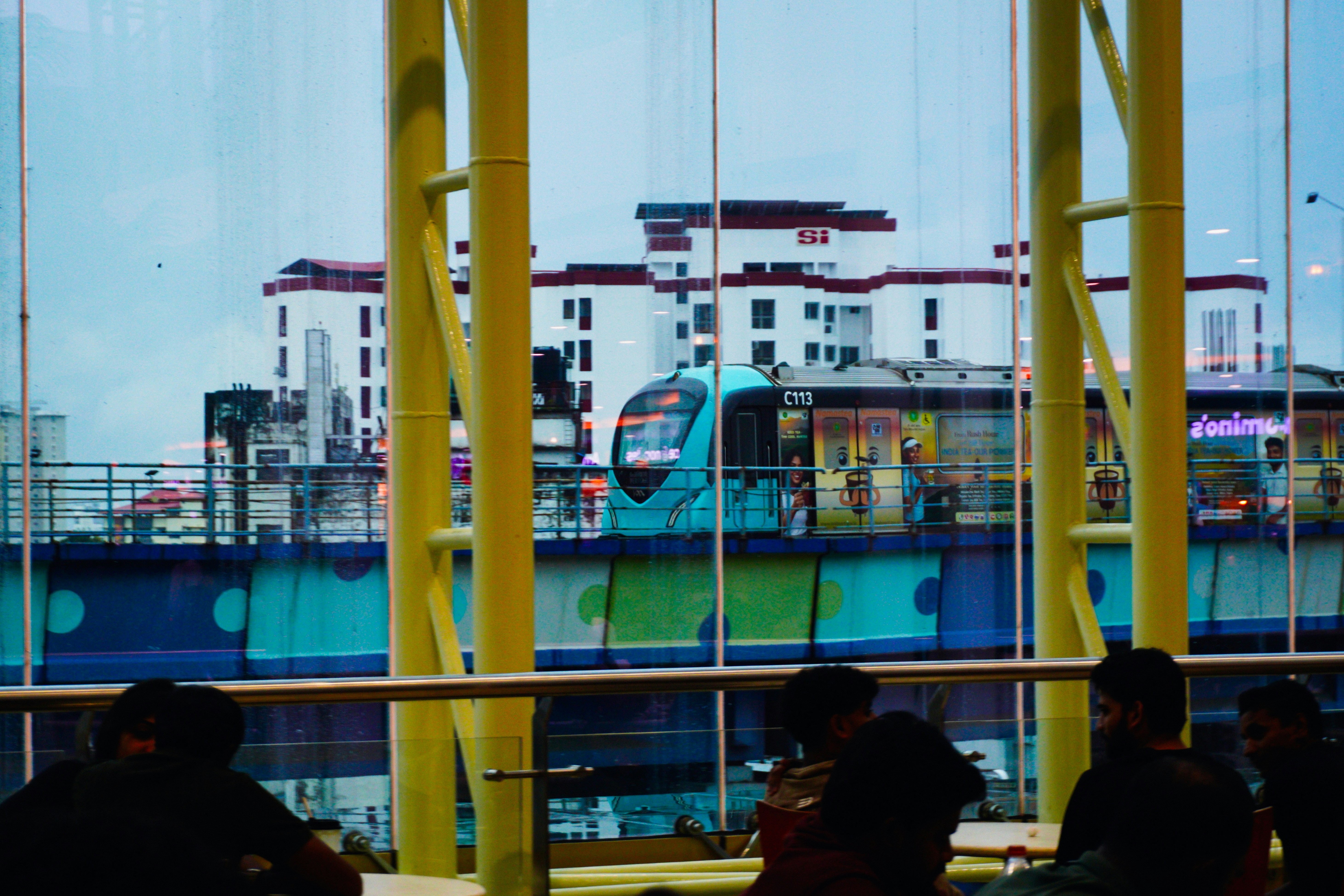 Bridge Transit: A Train Car Arches Through a City Waterfront