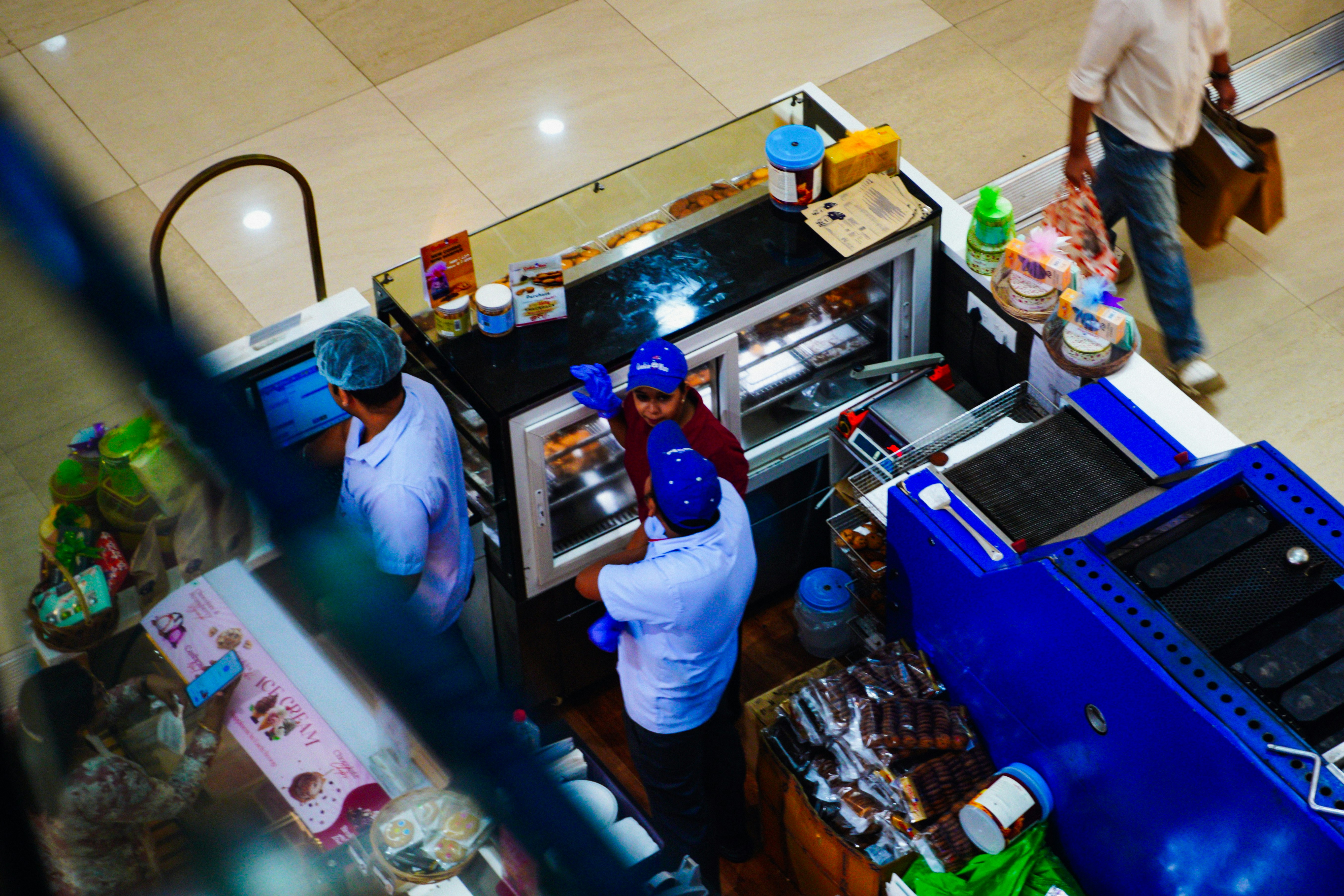 From Above the Counter: A Busy Convenience Scene in Motion