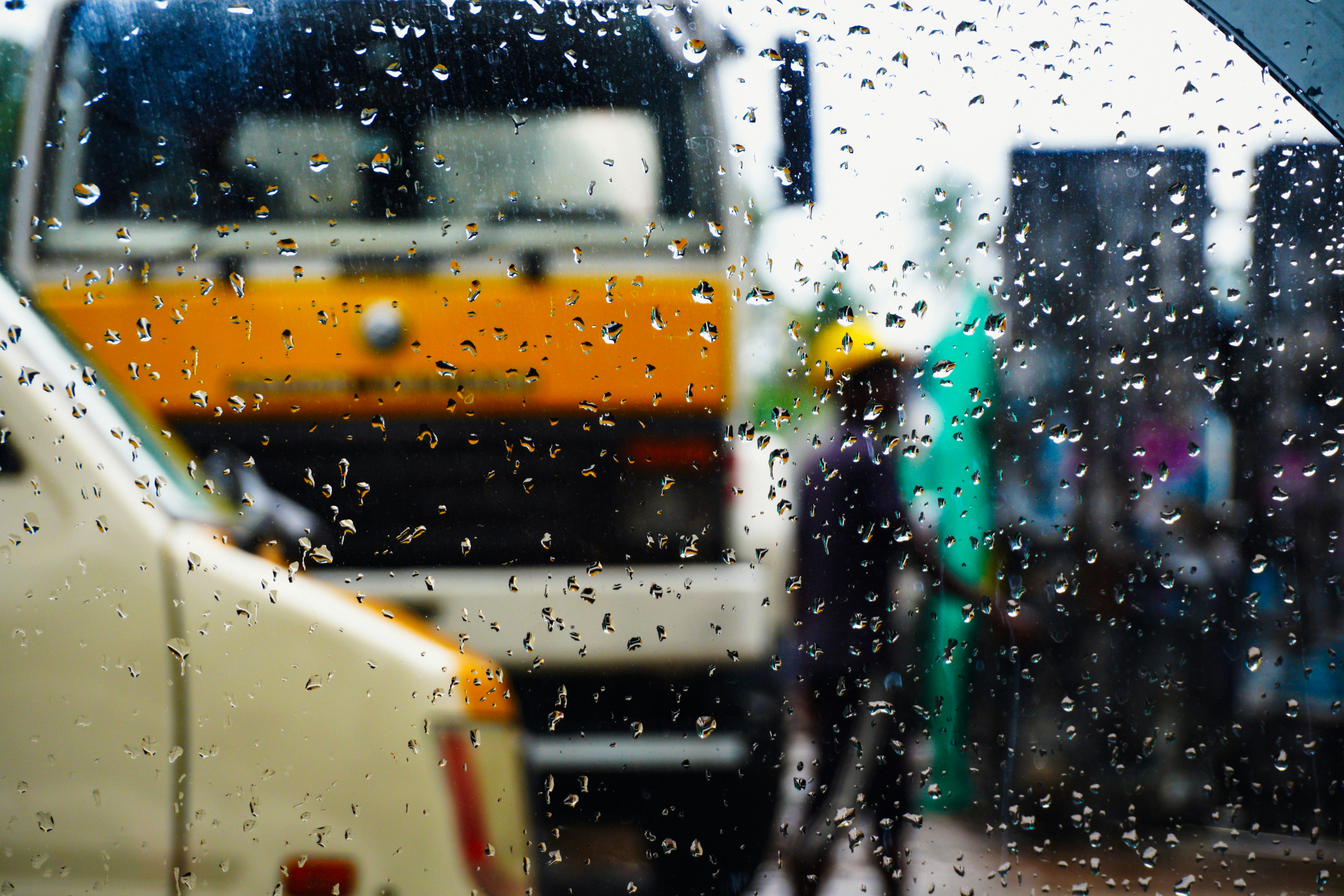 Rainy Street Scene: Blurred Parade Behind a Rain-Splashed Window