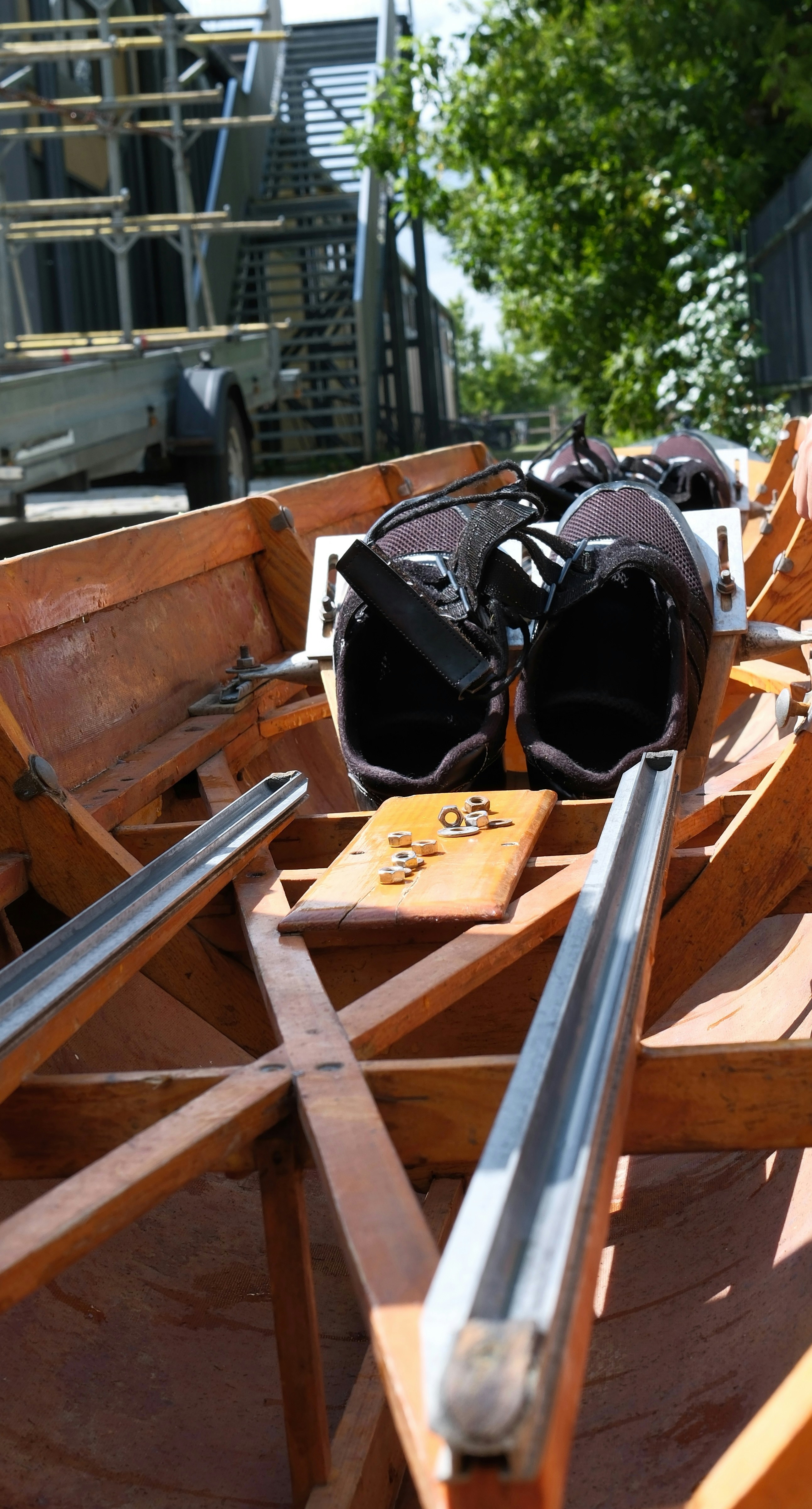 Handshake of Wood and Rails: Boots Resting in a Craft of Boat-Building