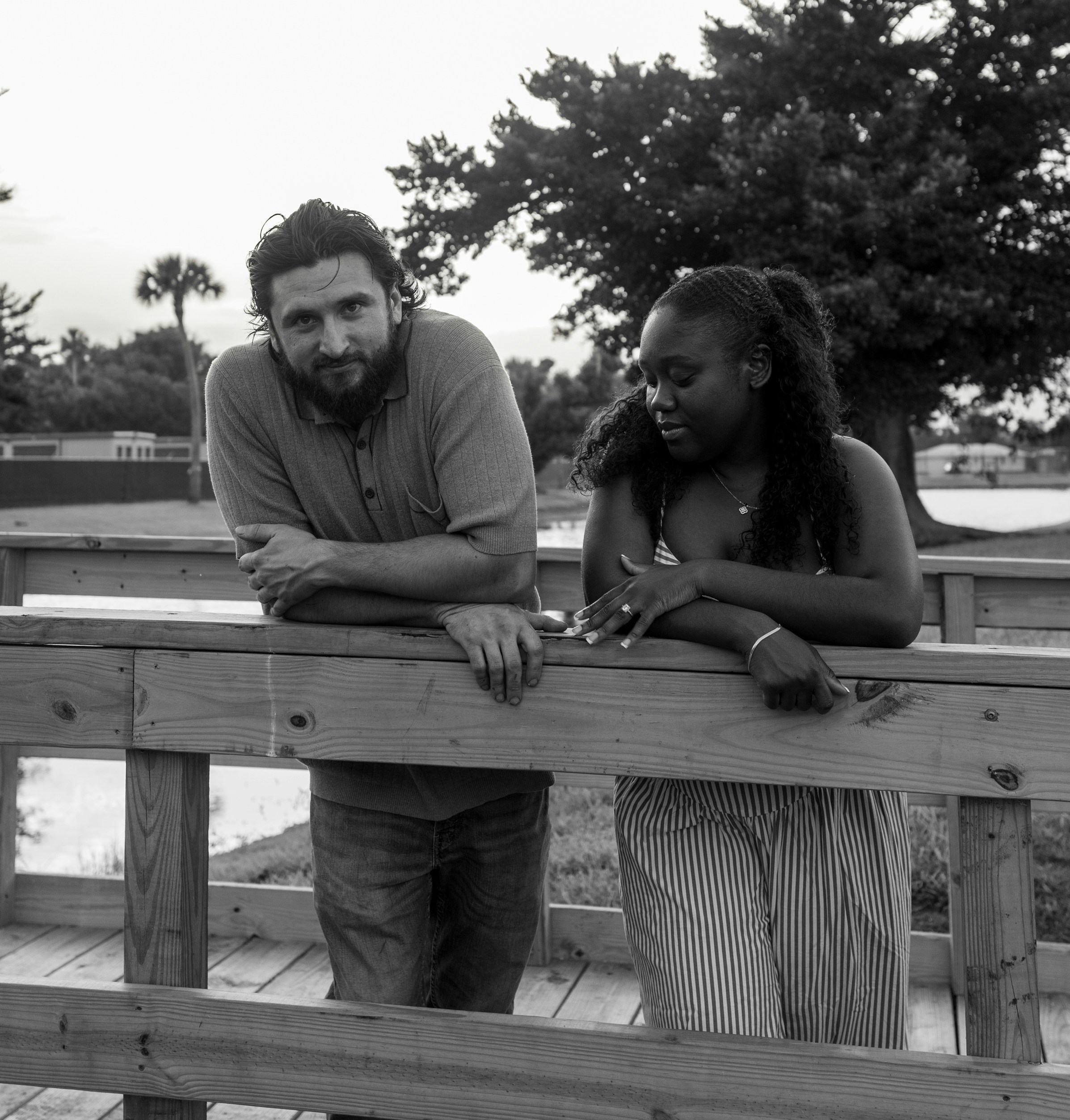 Two People at a Wooden Railing: Quiet Connection on a Weekend Porch
