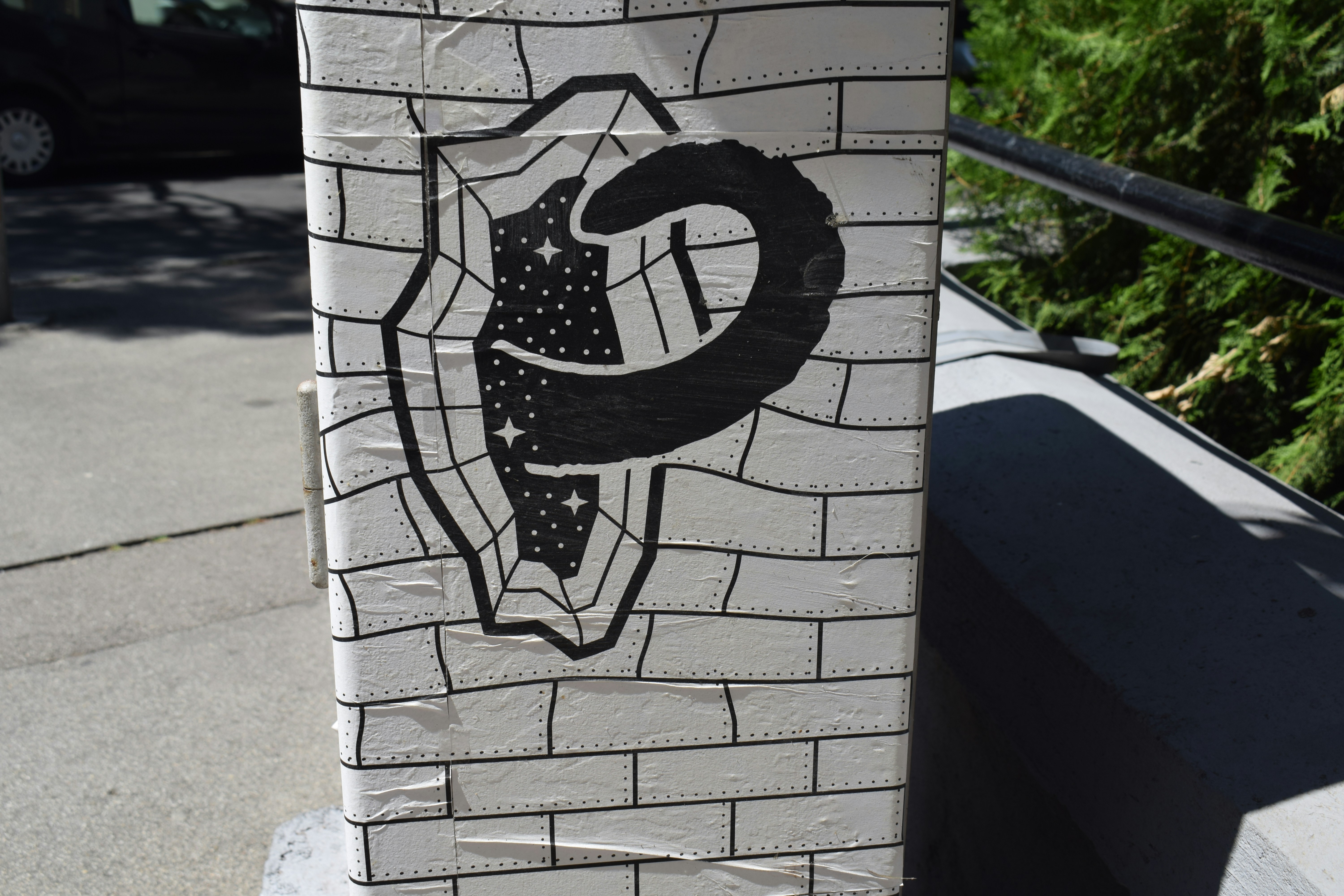 Mural on Brick Column: Abstract Shield with Starry Flag Pattern