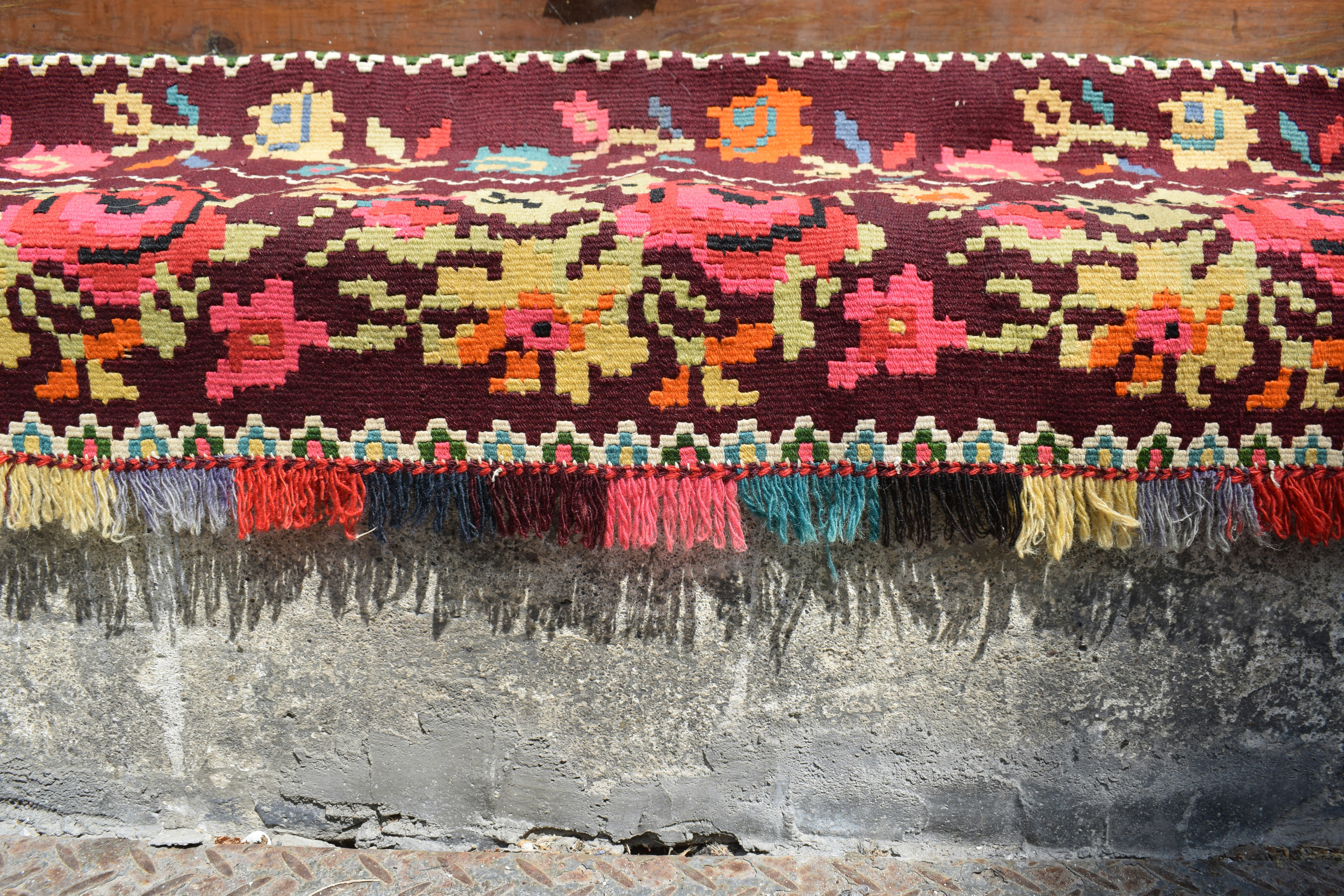 Colorful Fringed Rug Over Concrete Step
