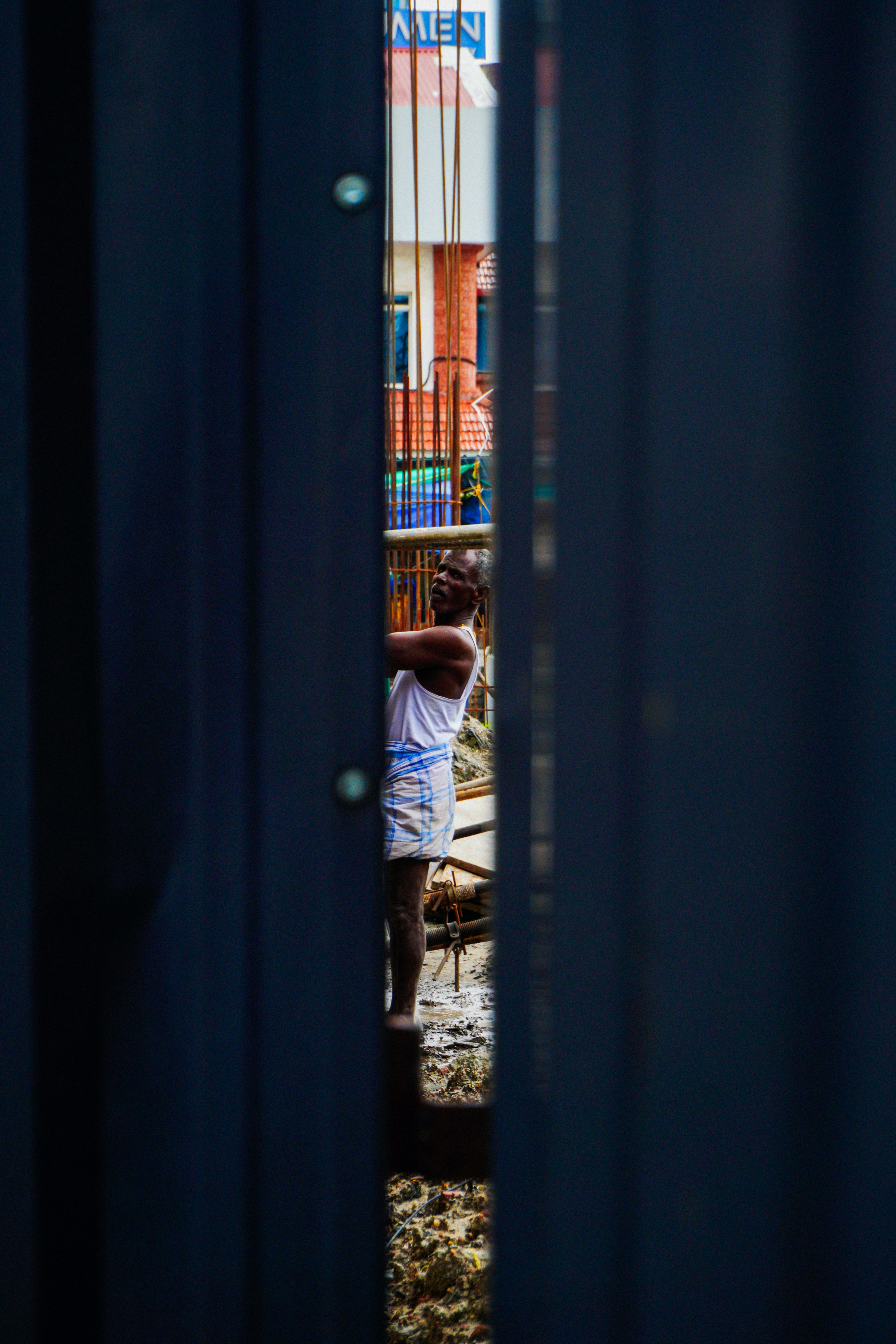 Between Slats: A Moment of Color and Grit