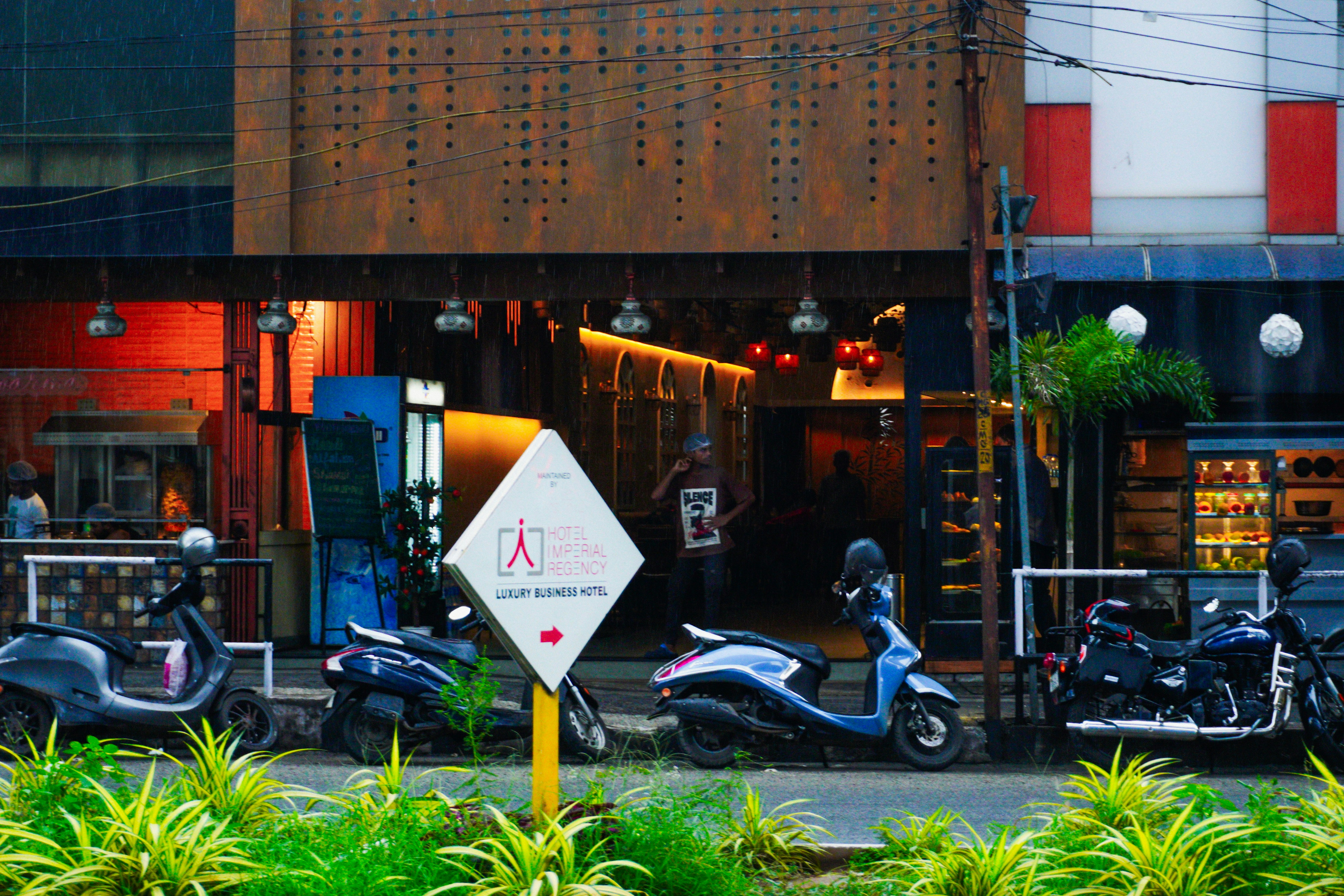 Shopfront Glow: Scooters and Signage Framing a Night Market