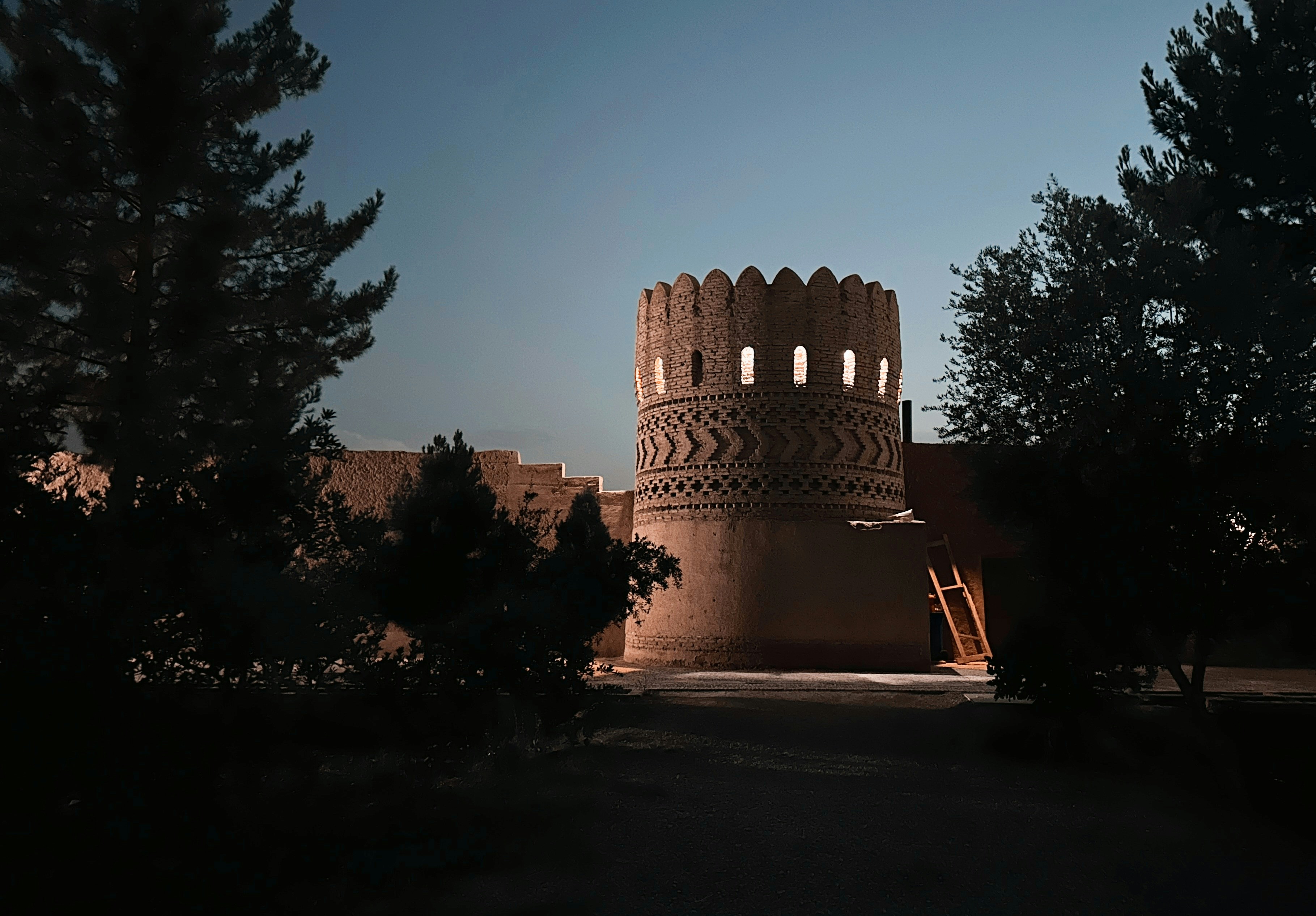 Moonlit Citadel: A Historic Turret Under Evening Fire