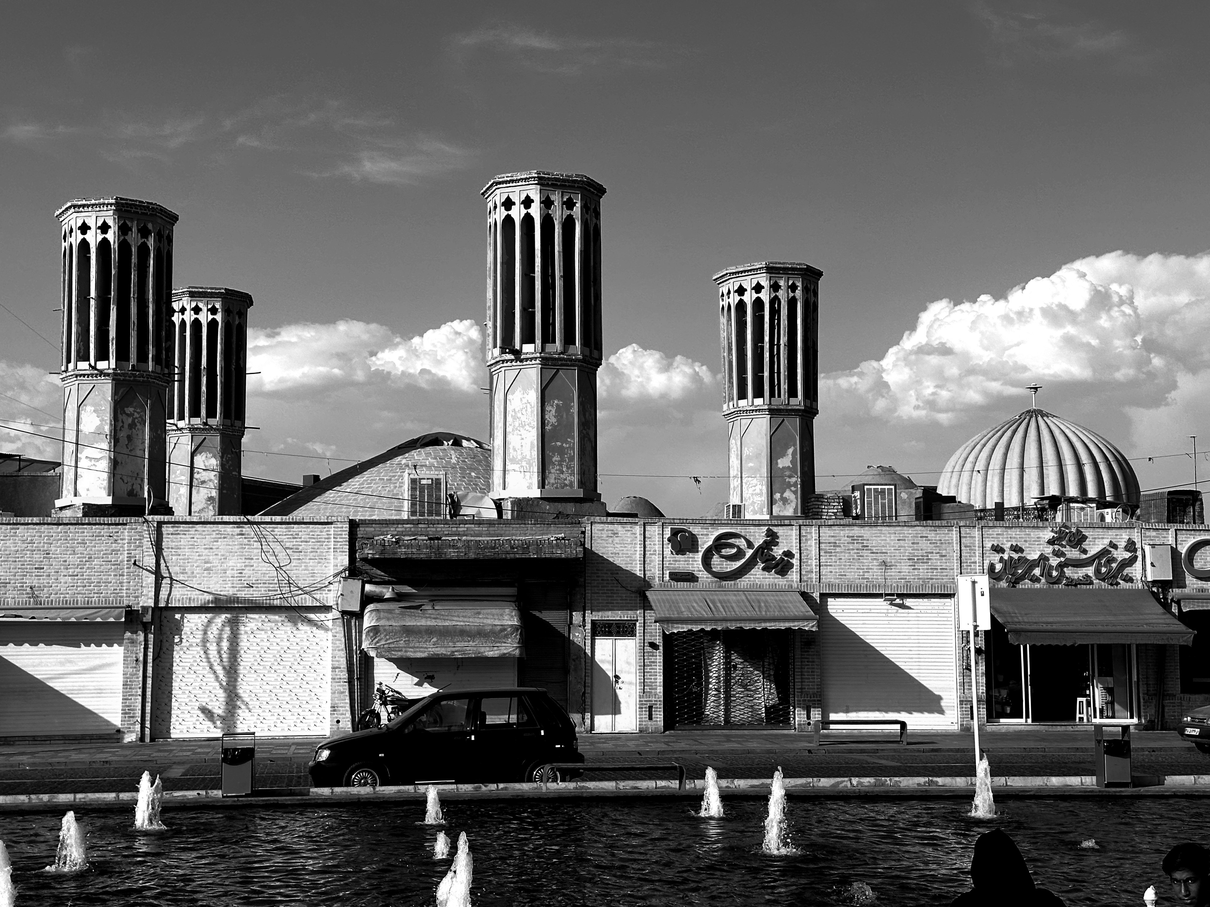 Urban Chimneys Over Water: A Monochrome Streetfront