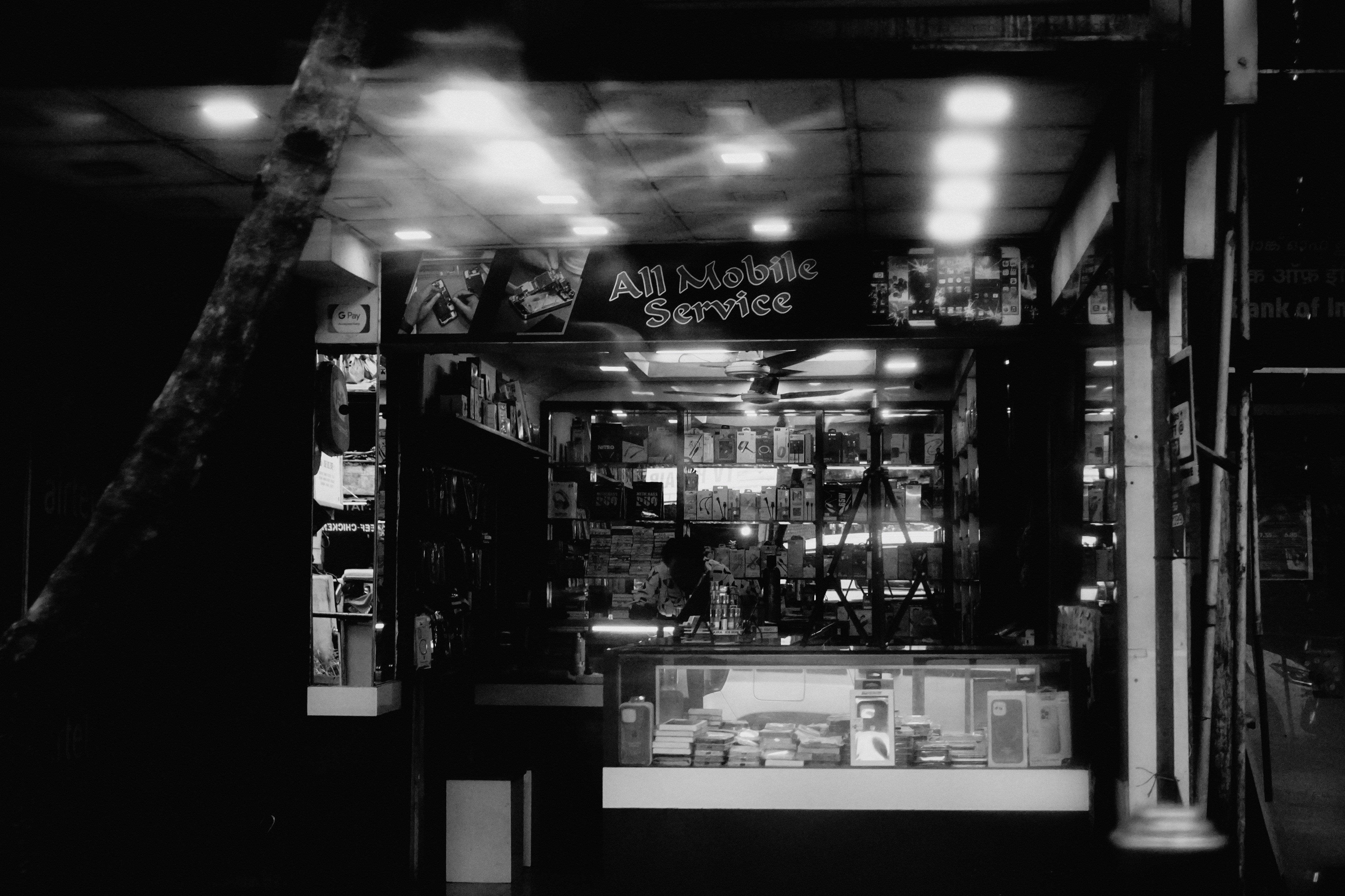 Nightlife at the All Mobile Service: A Quiet Payment Window in Black and White