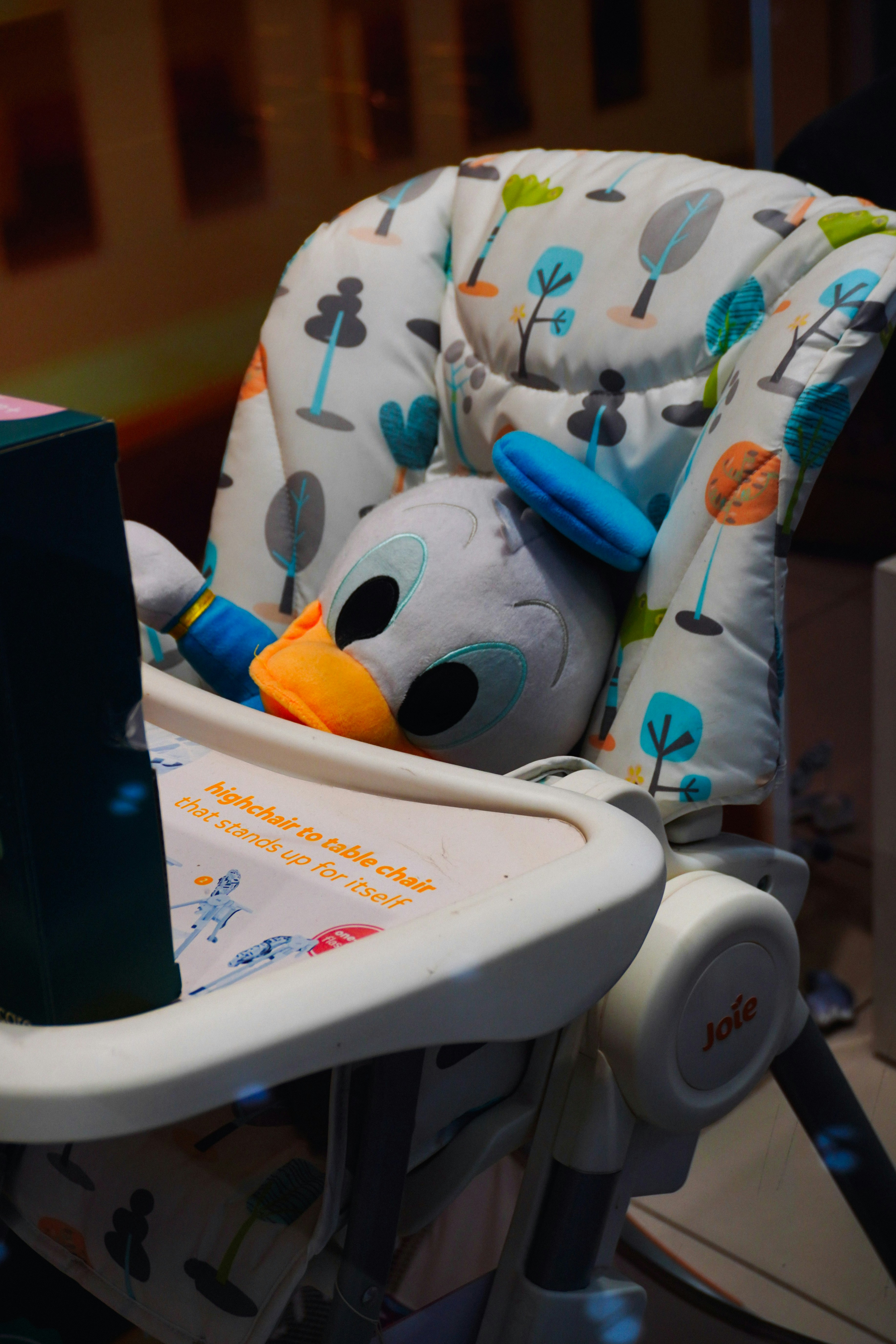 Duckling on a High Chair: Colorful Forest Pattern Meets Quiet Curiosity