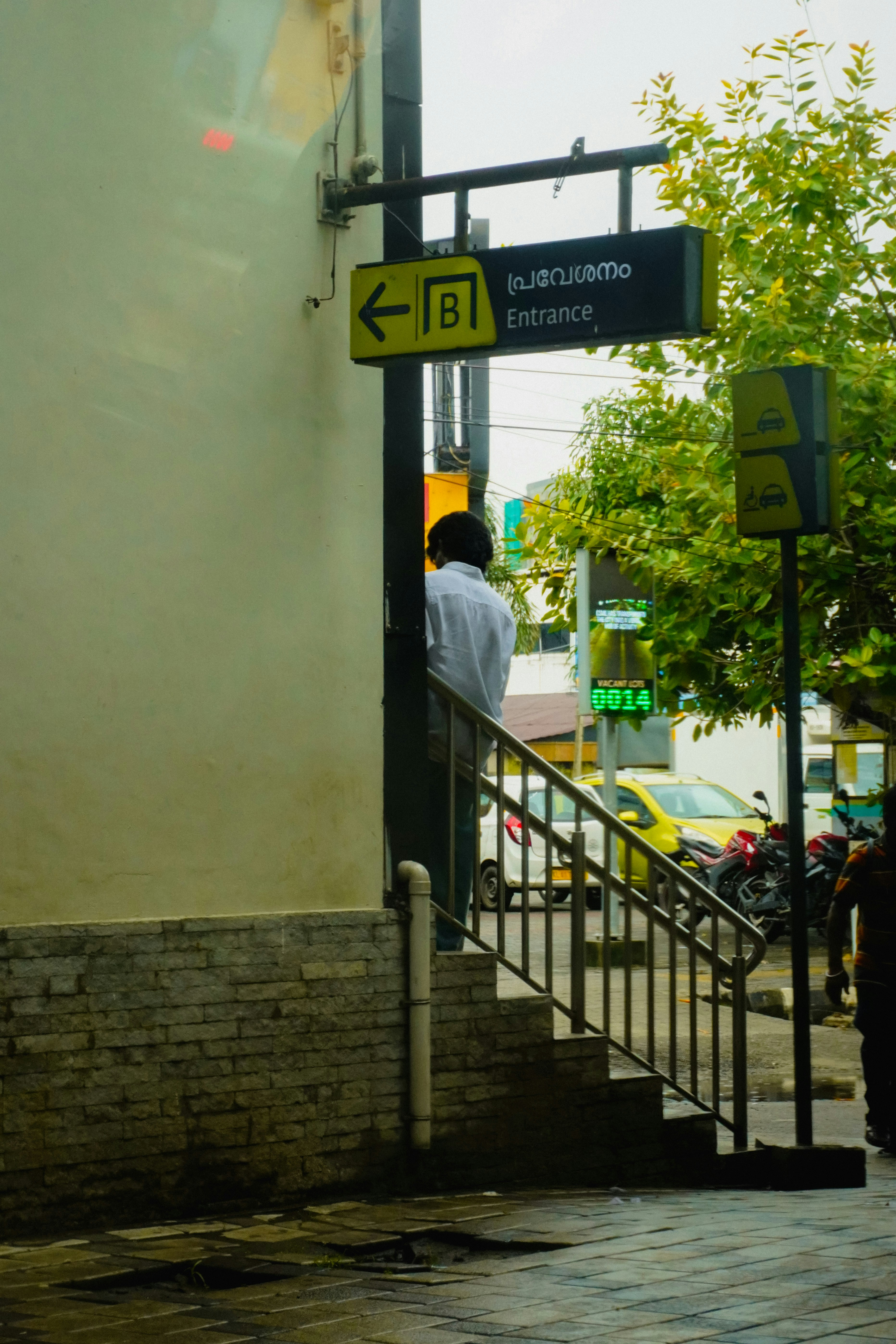 Steps to the Street Sign: A Quiet Moment at the Entrance