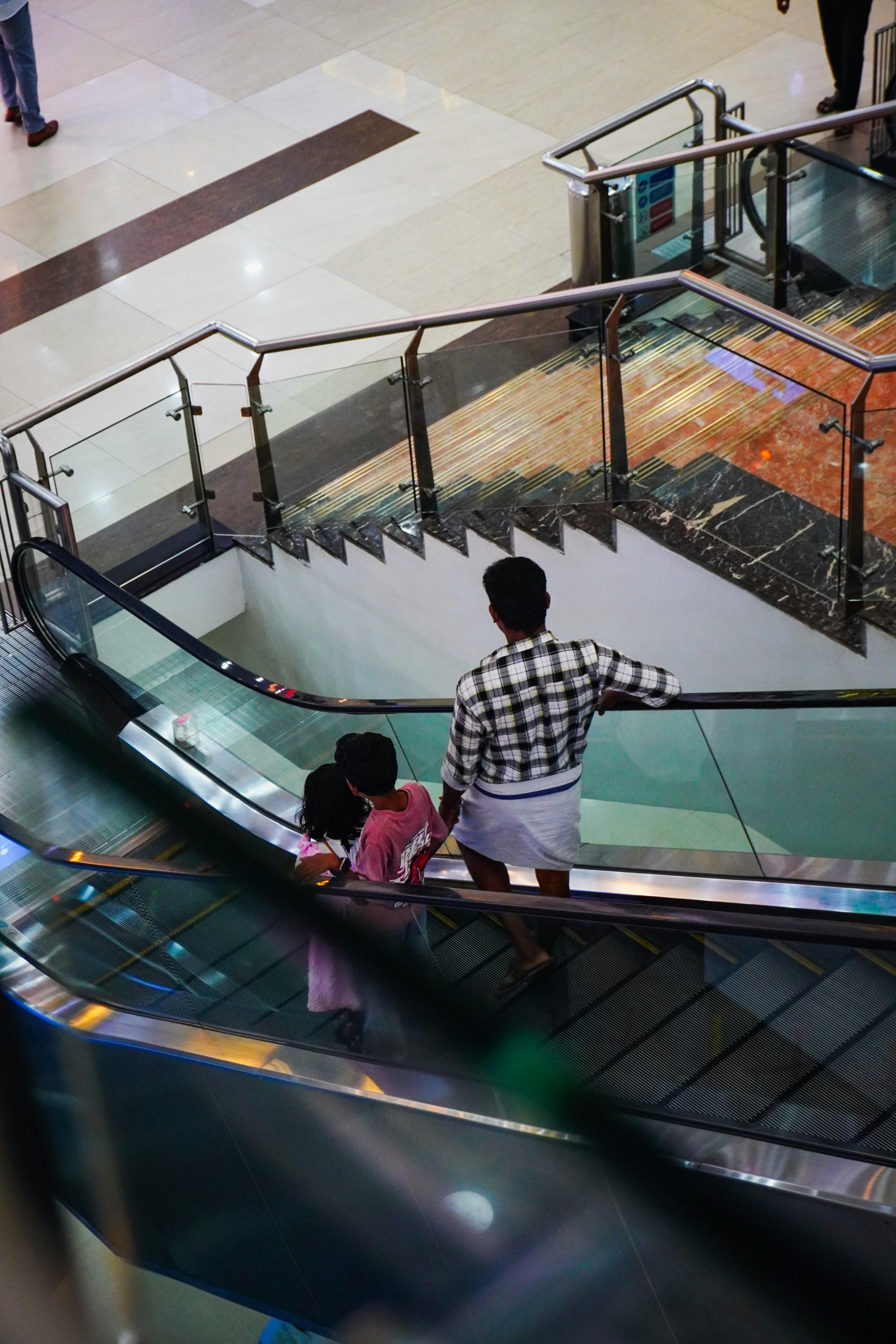Escalator Ascent: A Family's Pause on the Move