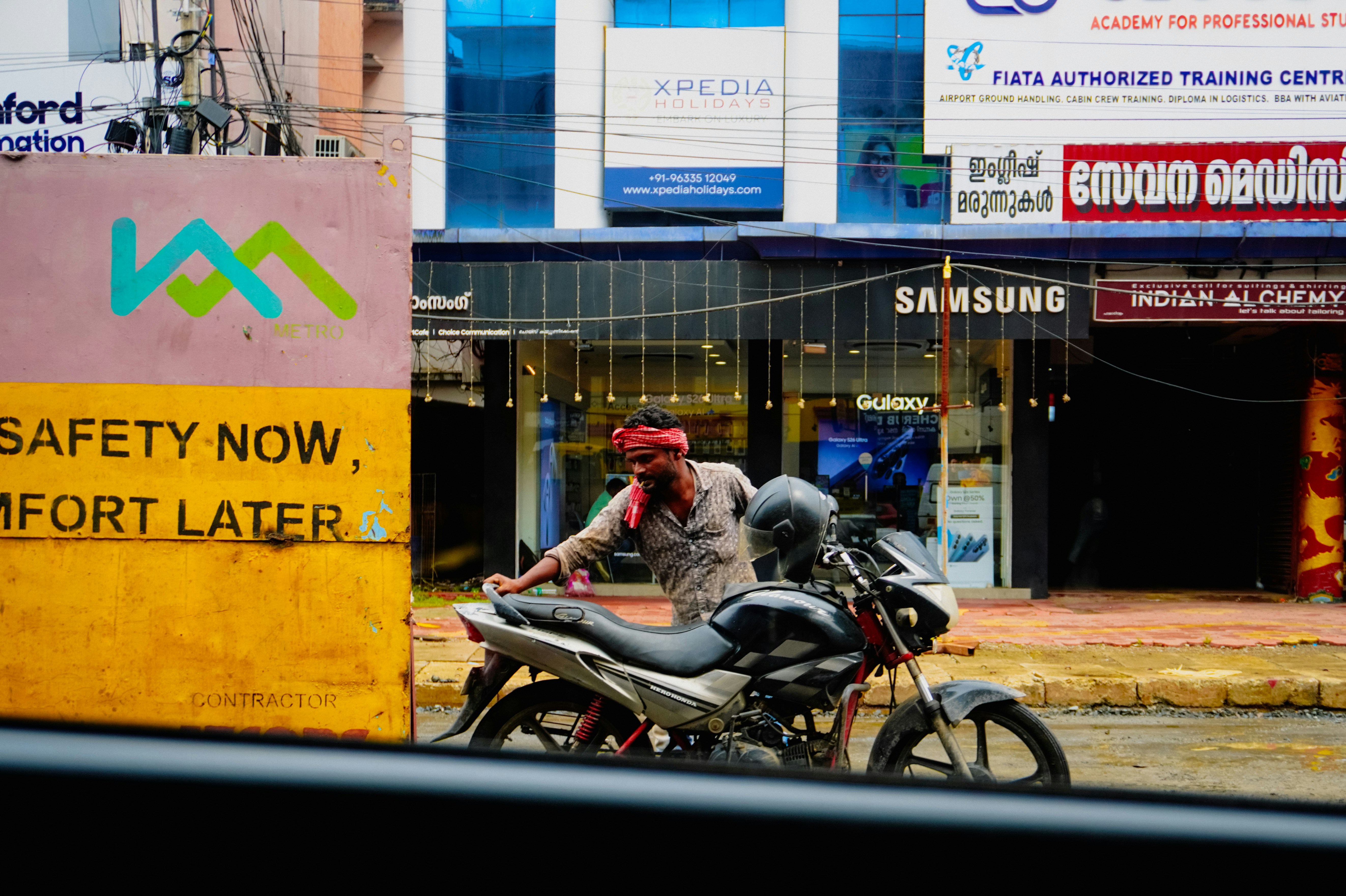 Motorcycle Rider in a Busy Street, Framed by a Shopfront Corridor