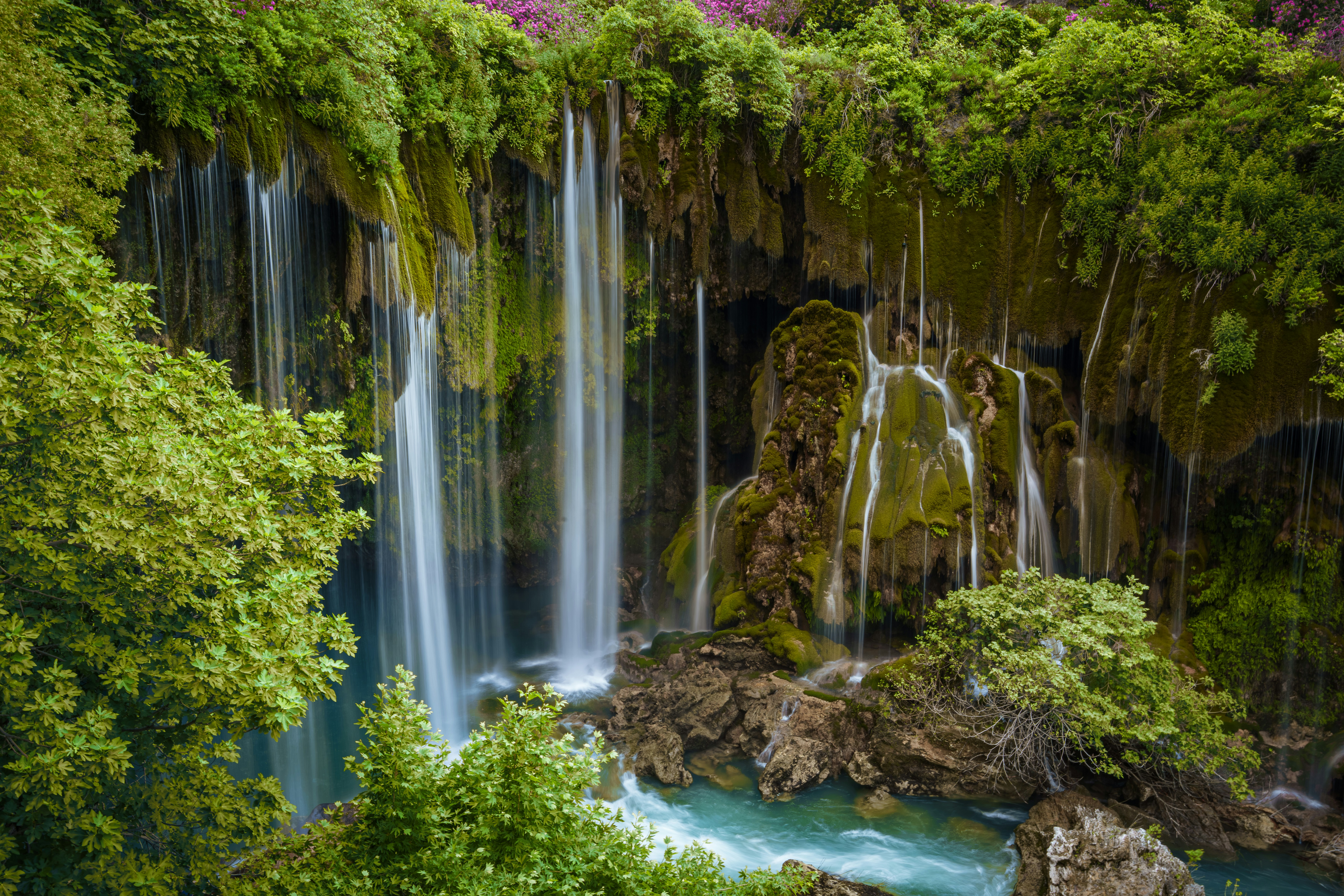 Emerald Veil: Cascades Releasing Into Turquoise Pools