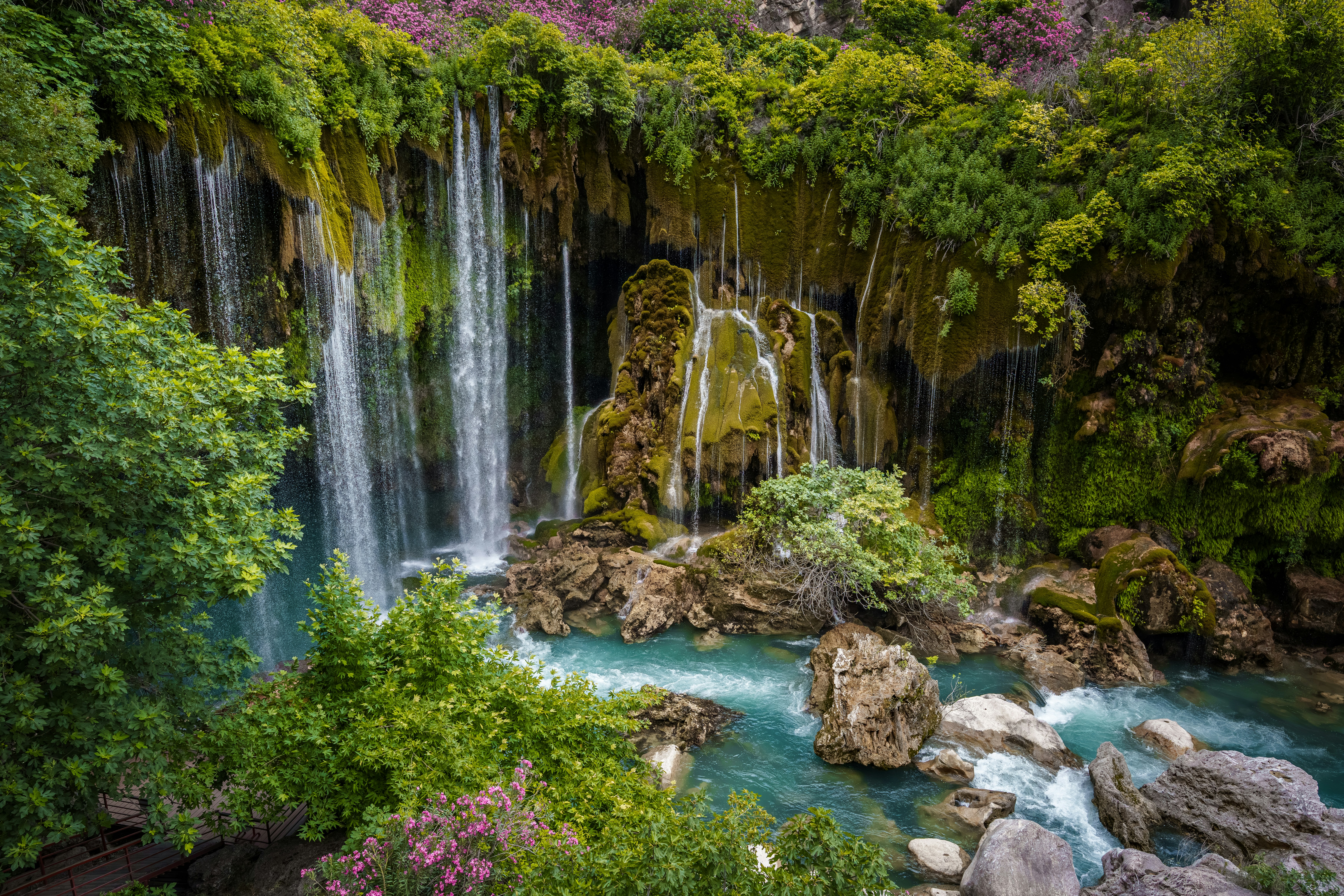 Emerald Veil: A Cascade Surrounded by Verdant cliffs