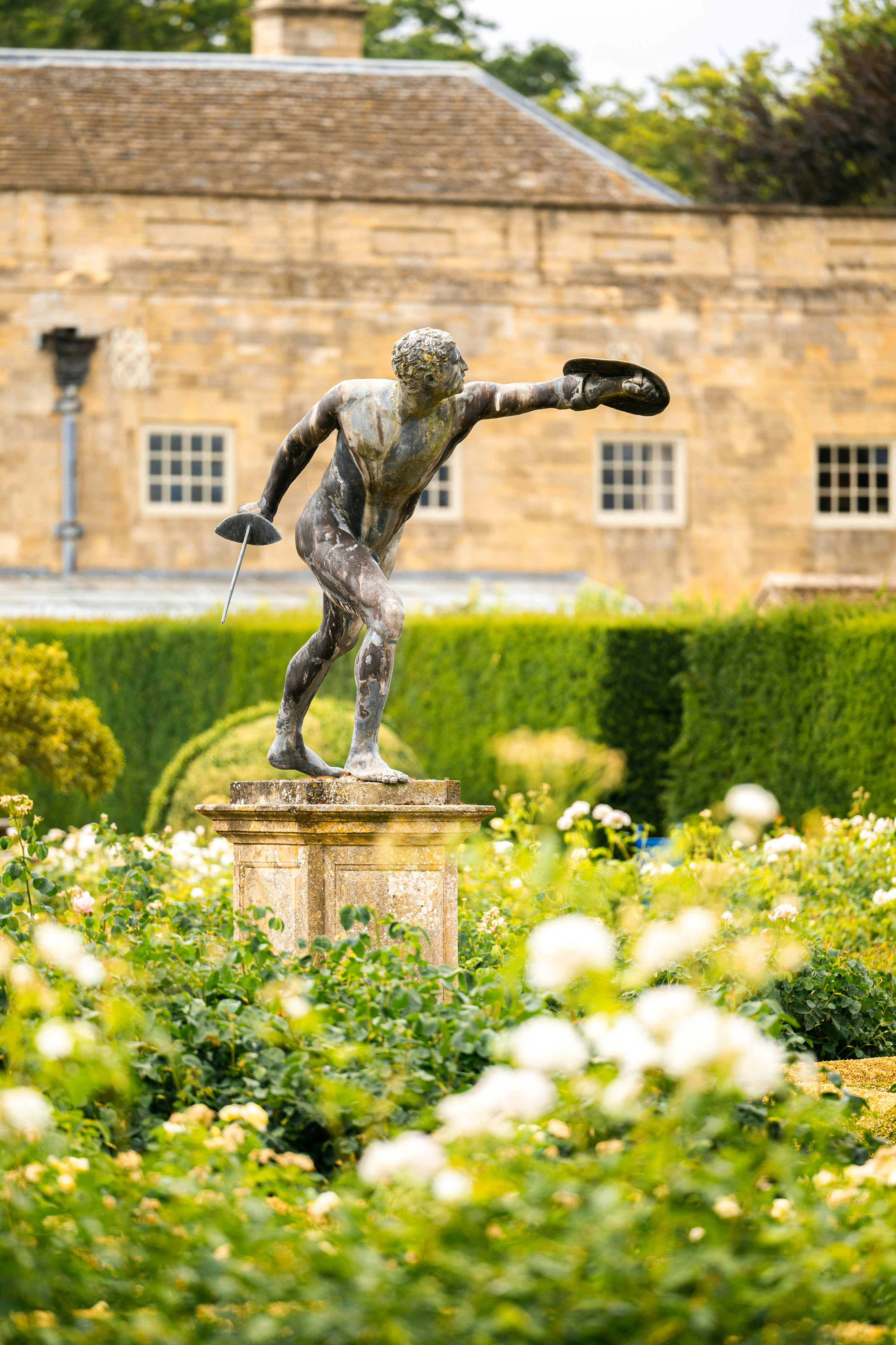 Stone Archer in a Sunlit Garden