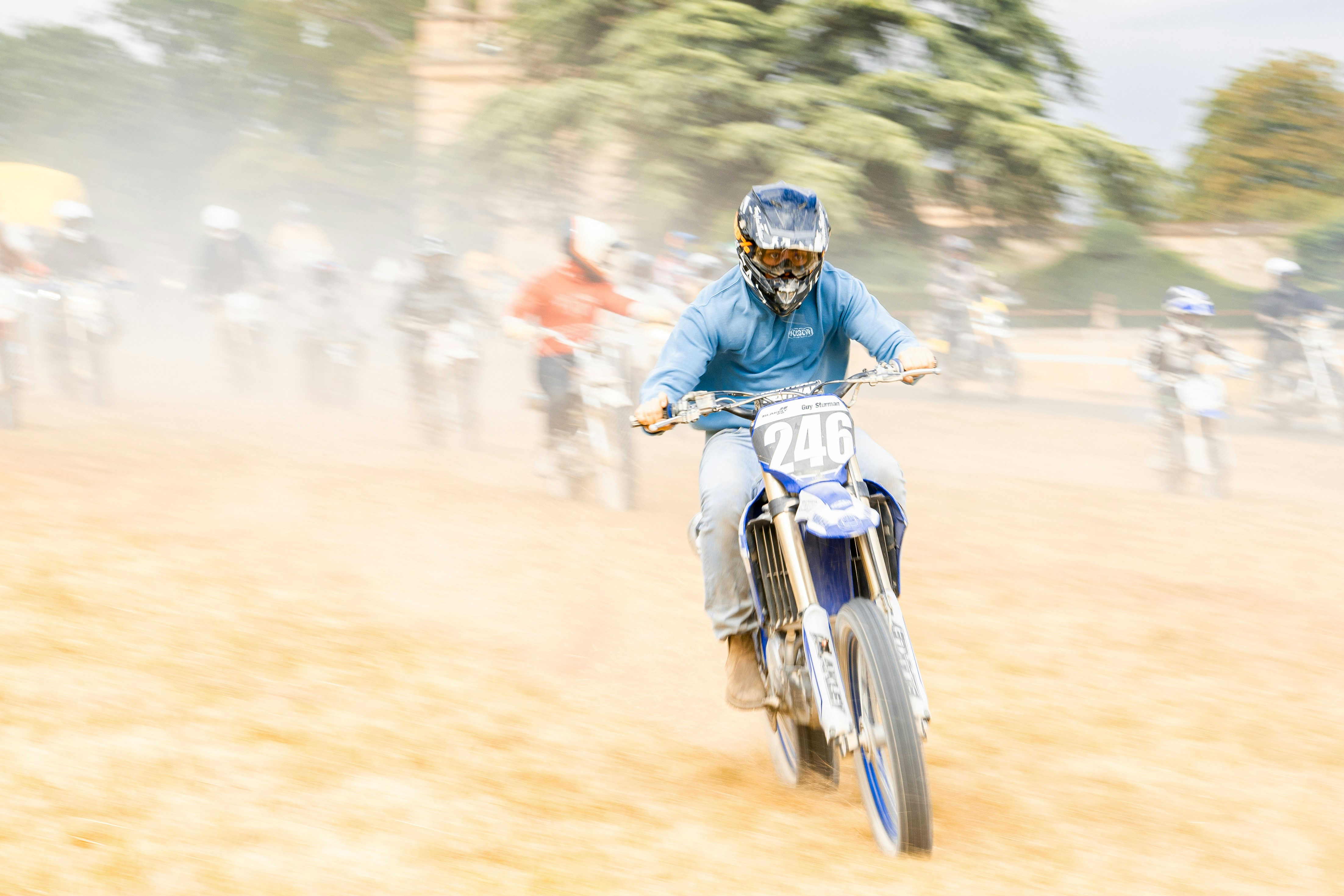 Dusty Dash: Rider in Motion on a Dusty Track