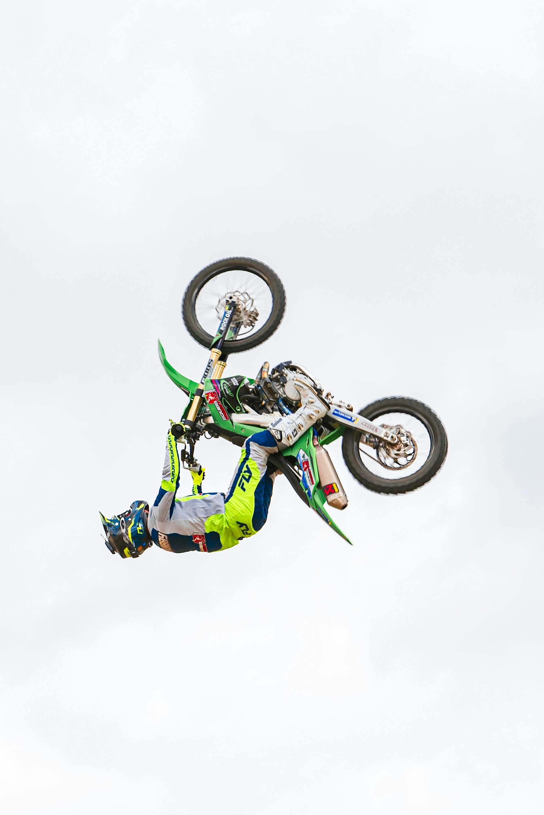 Aerial flips: neon-green rider defies gravity mid-stunt