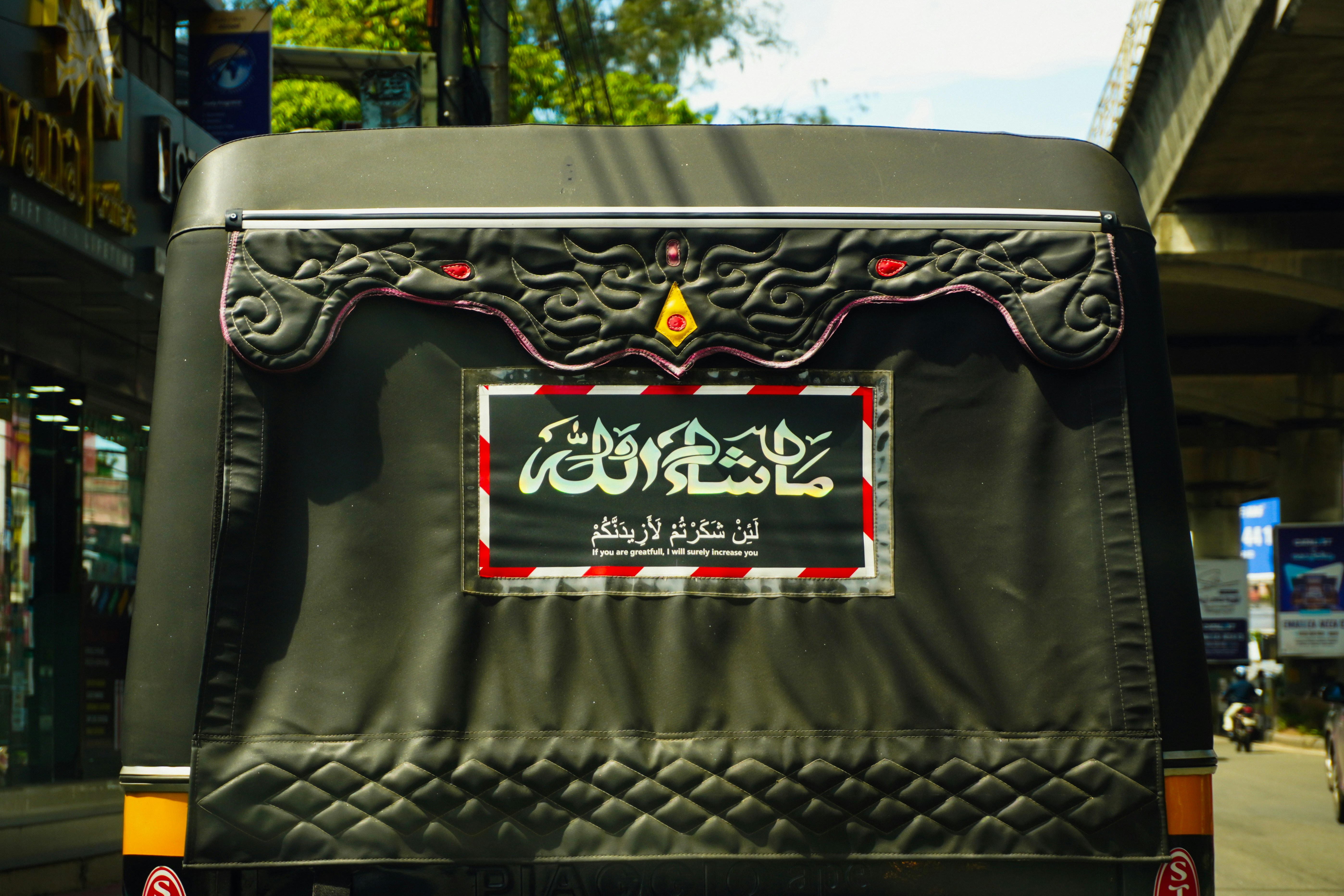 Embroidered Transit Veil: The Back of a Decorated Vehicle