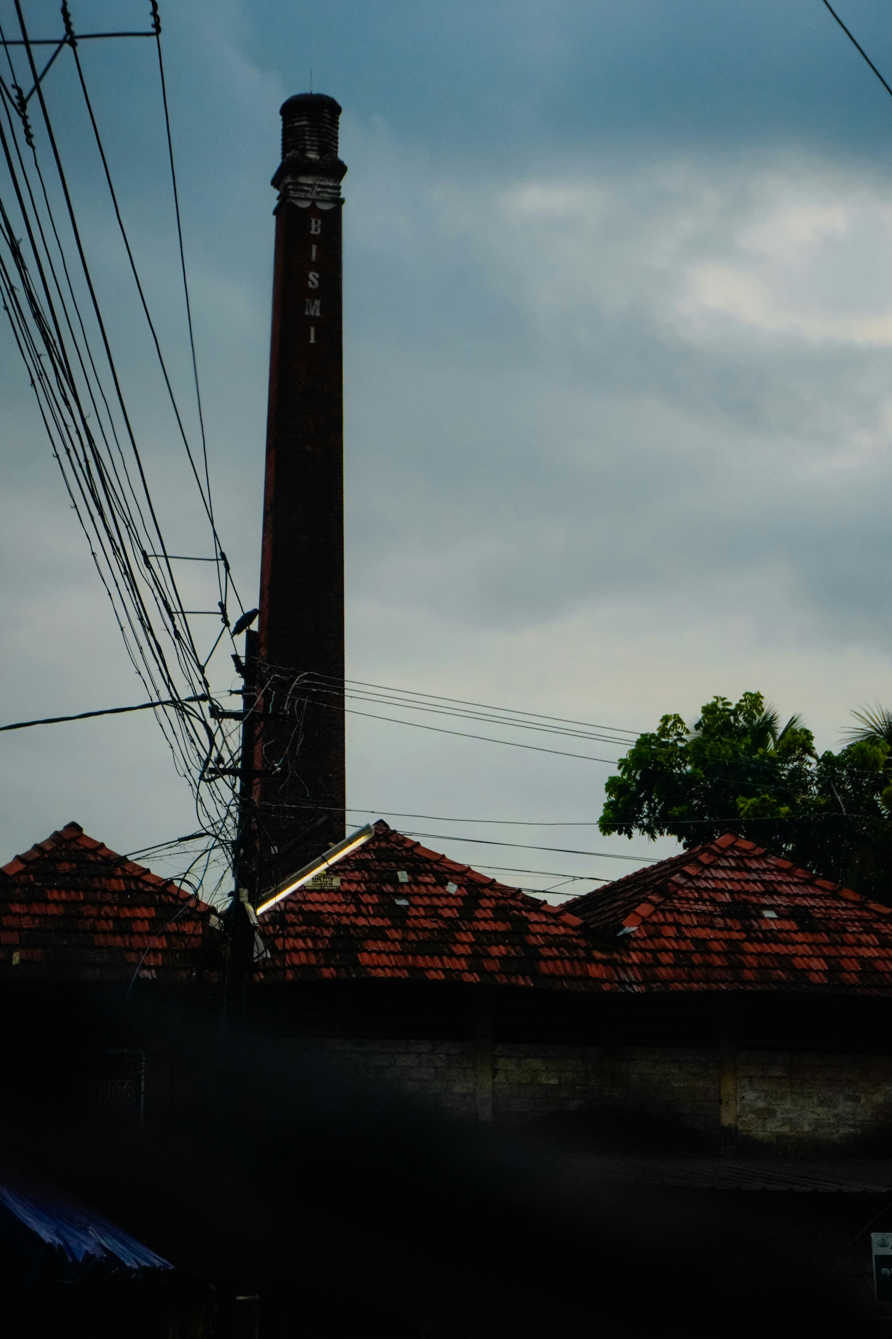 Chimney Sentinel Over Red-Tiled Rooftops