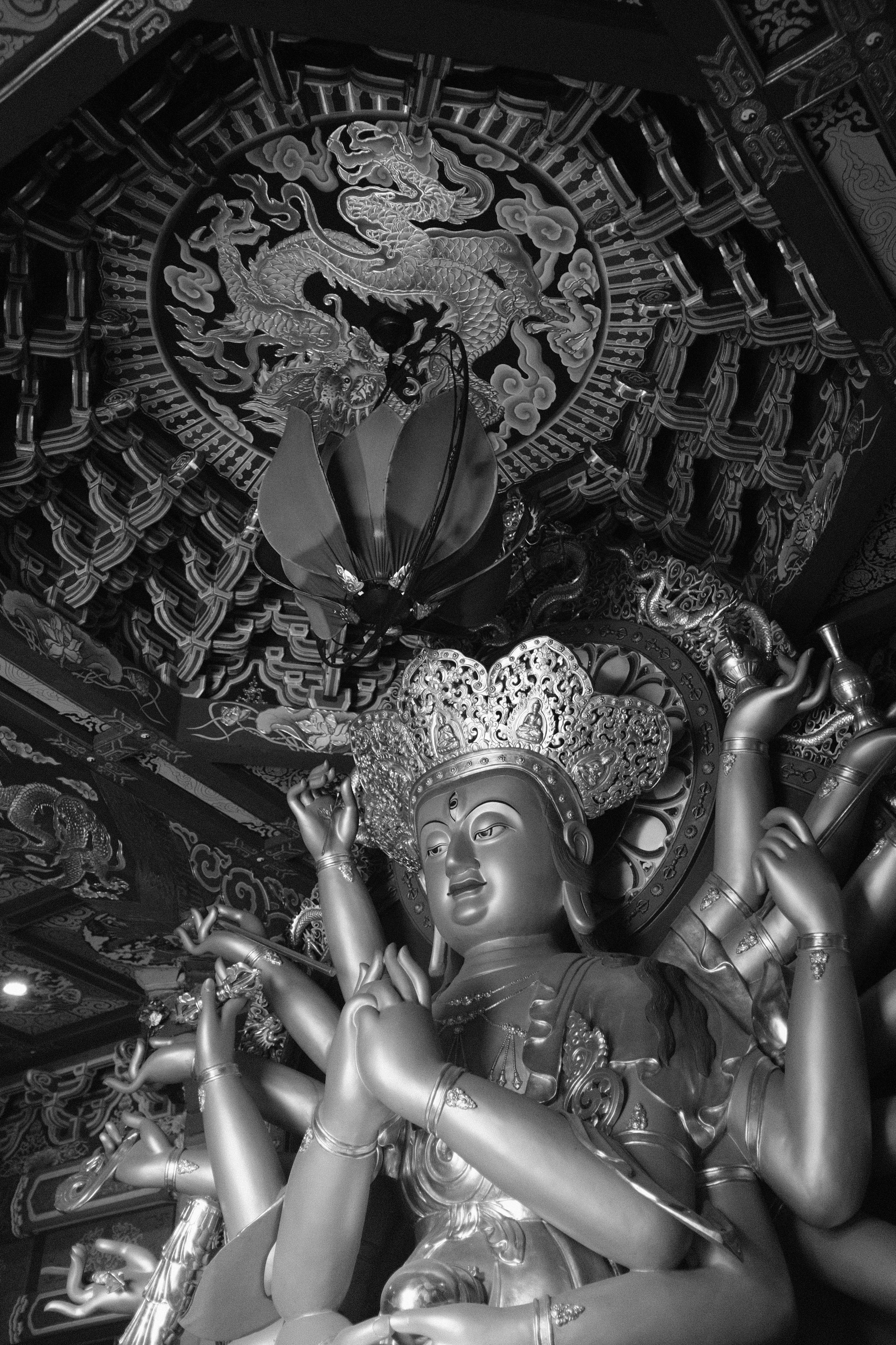 Ritual Guardians: A Multi-Armed Statue Emerges from the Temple Ceiling